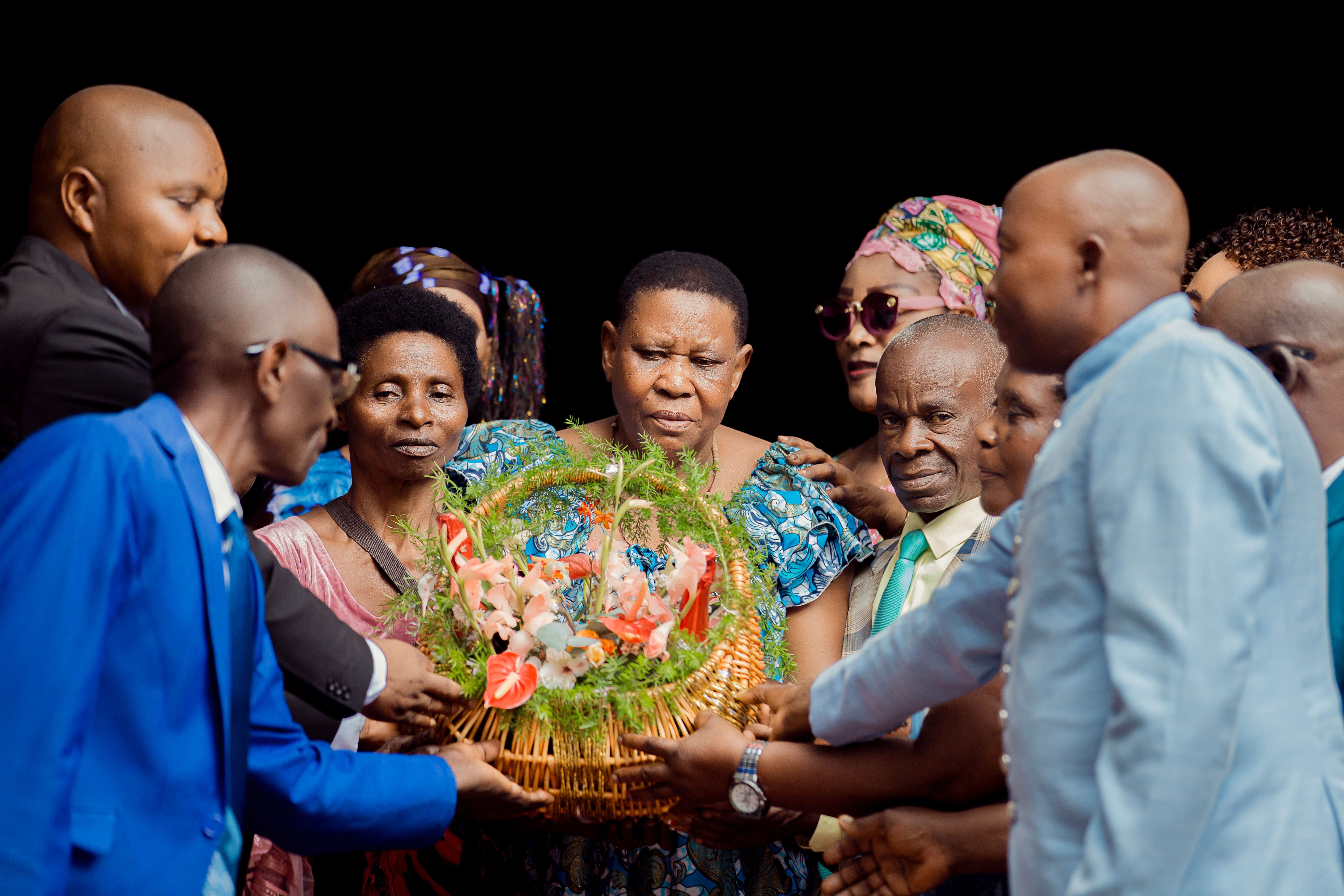 Diverse Group Holding Floral Basket in Celebration · Free Stock Photo
