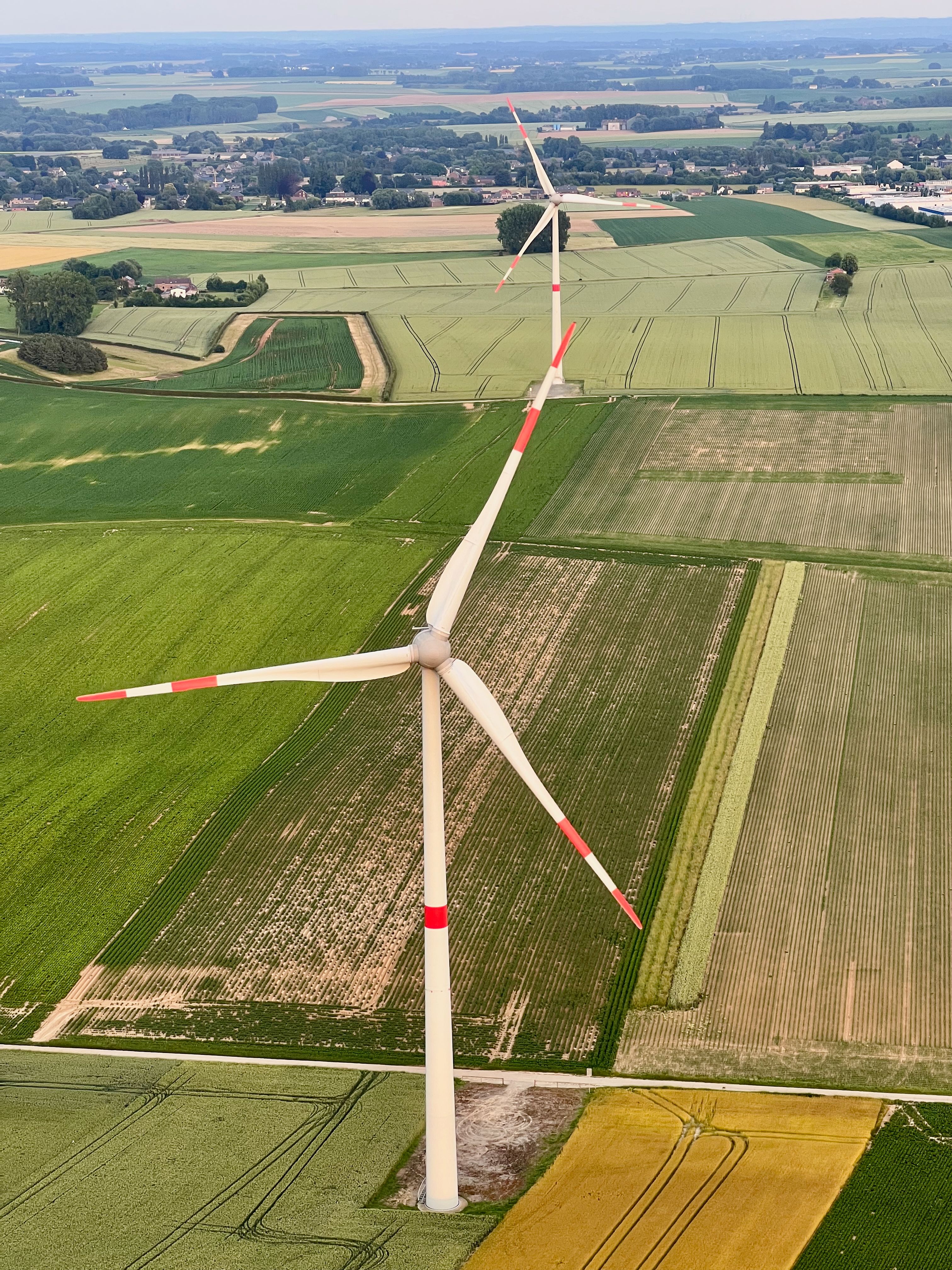 Aerial View of Wind Turbines in Green Fields · Free Stock Photo