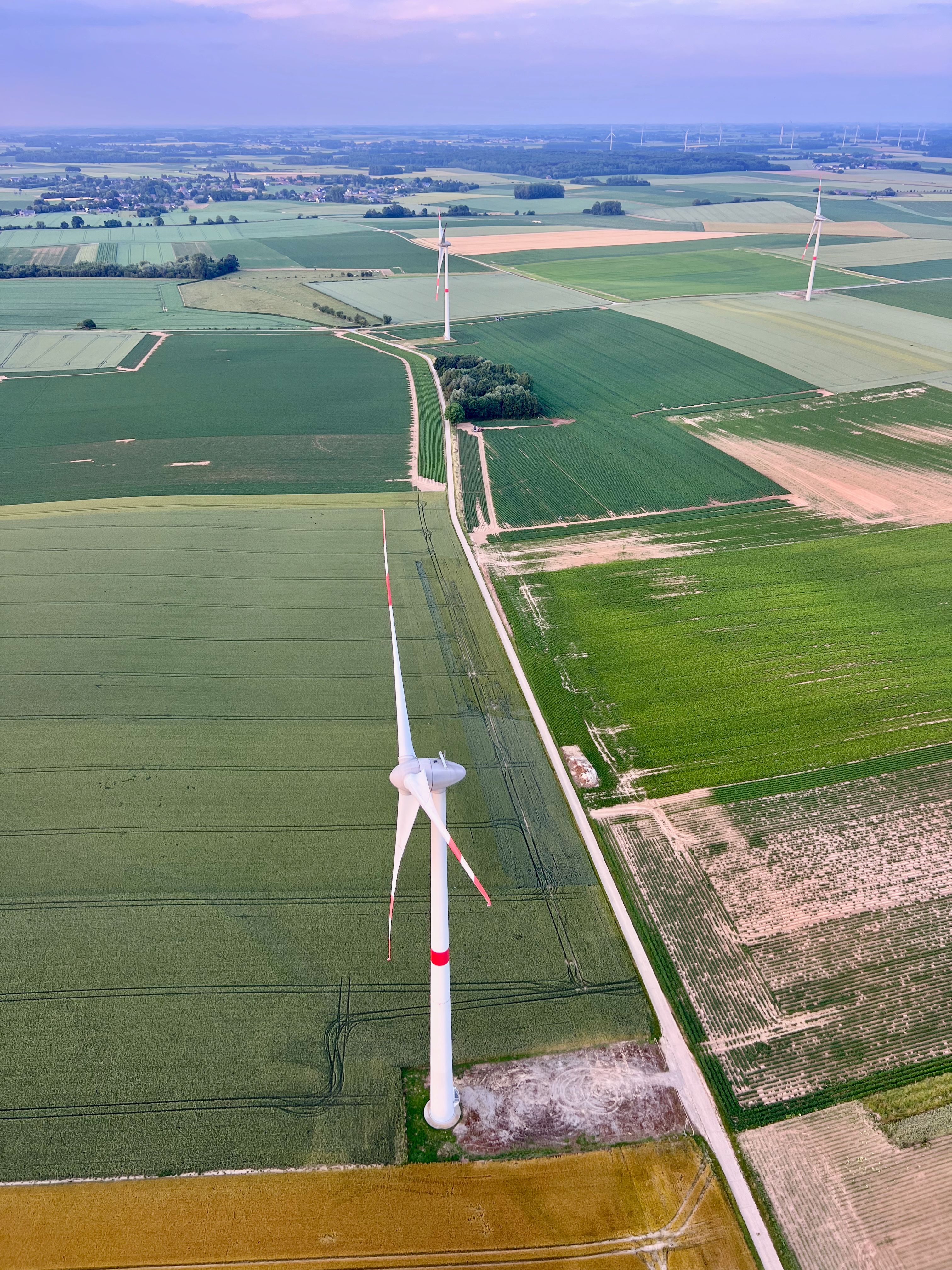 Aerial View of Wind Turbines Over Farmland Fields · Free Stock Photo