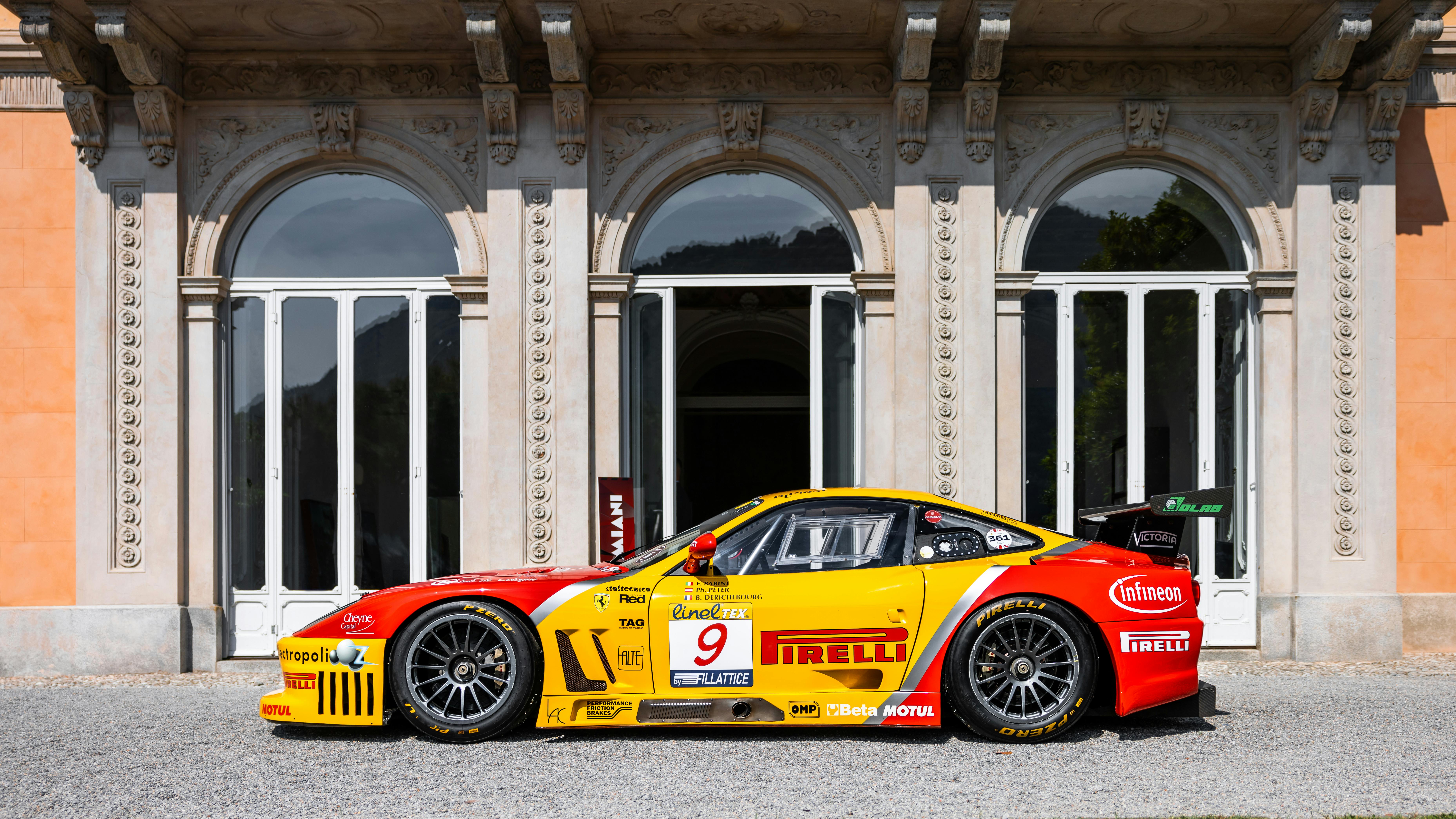 Vibrant Red and Yellow Racing Car in Front of Mansion · Free Stock Photo