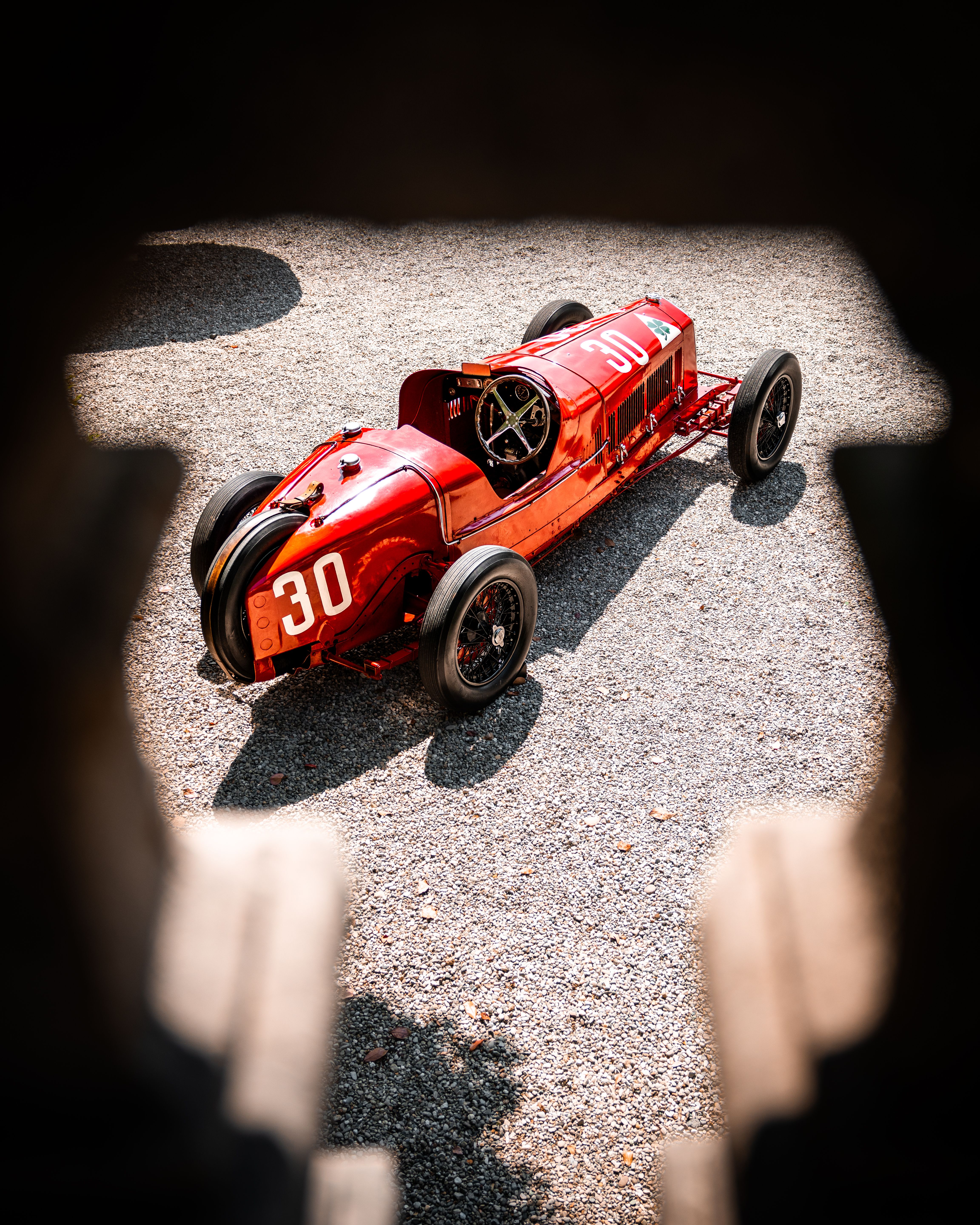 Vintage Red Race Car on Gravel Track · Free Stock Photo