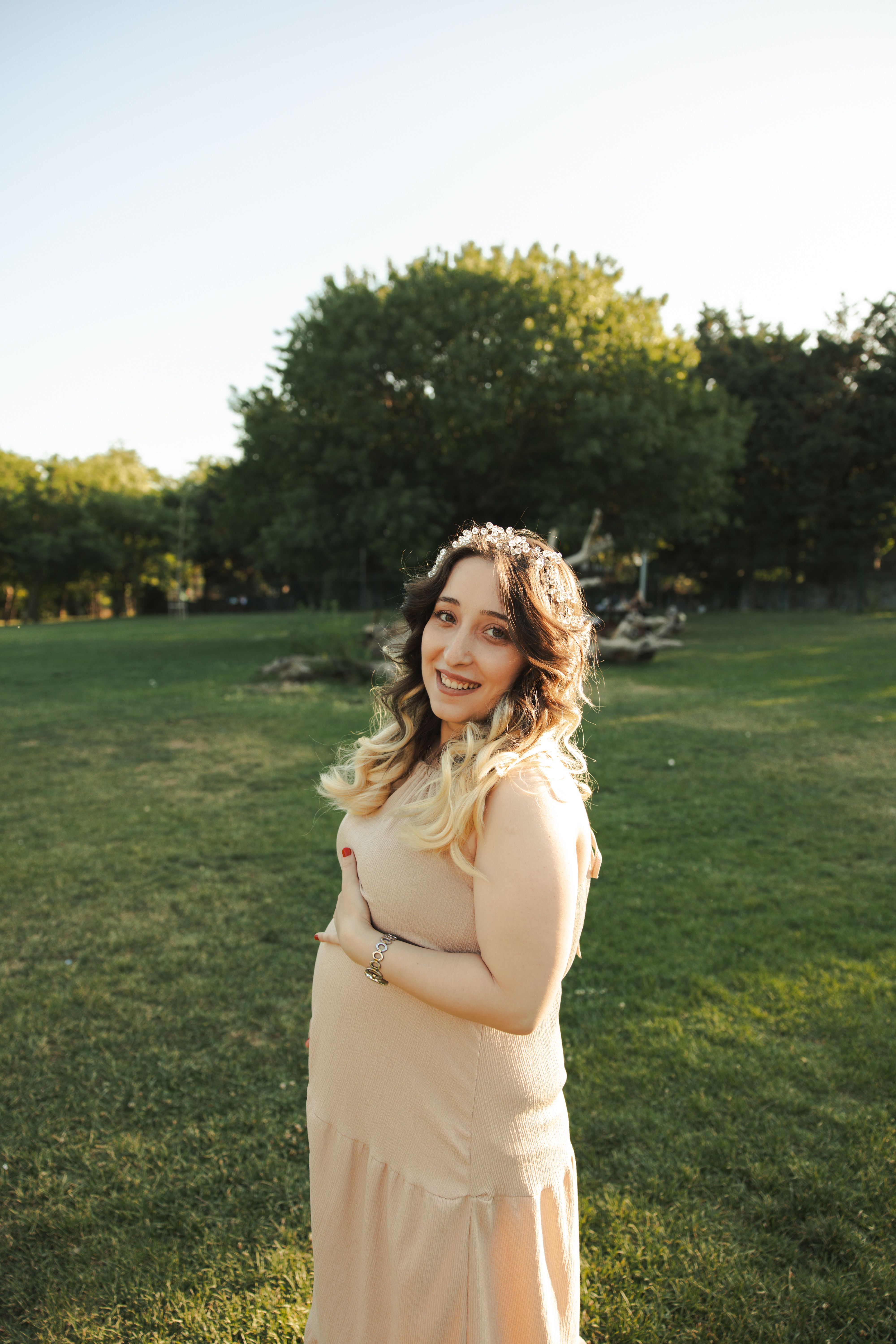 A Happy Pregnant Woman in a White Outfit Holding her Belly · Free Stock ...