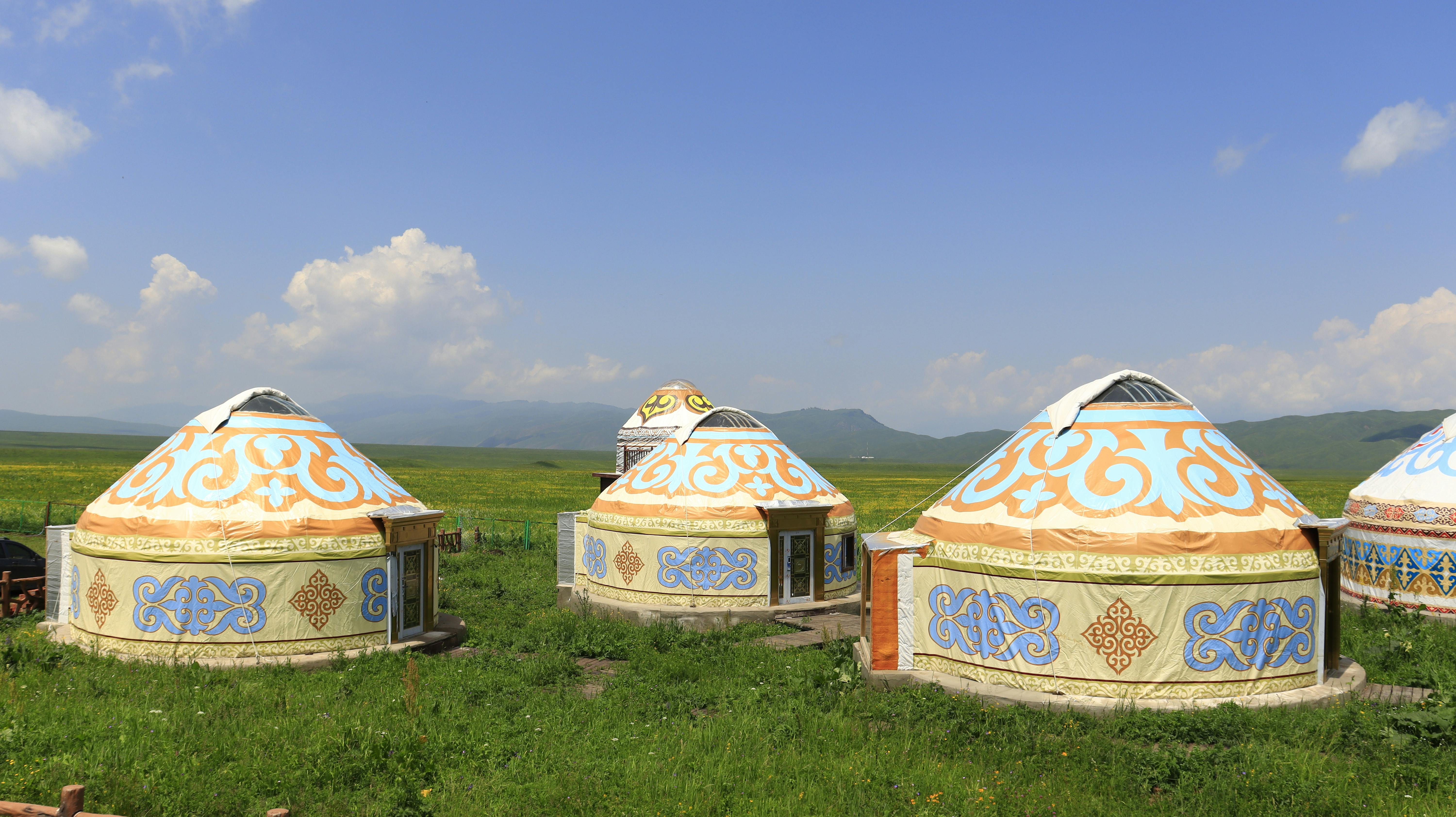 Traditional Yurts in a Scenic Grassland Setting · Free Stock Photo