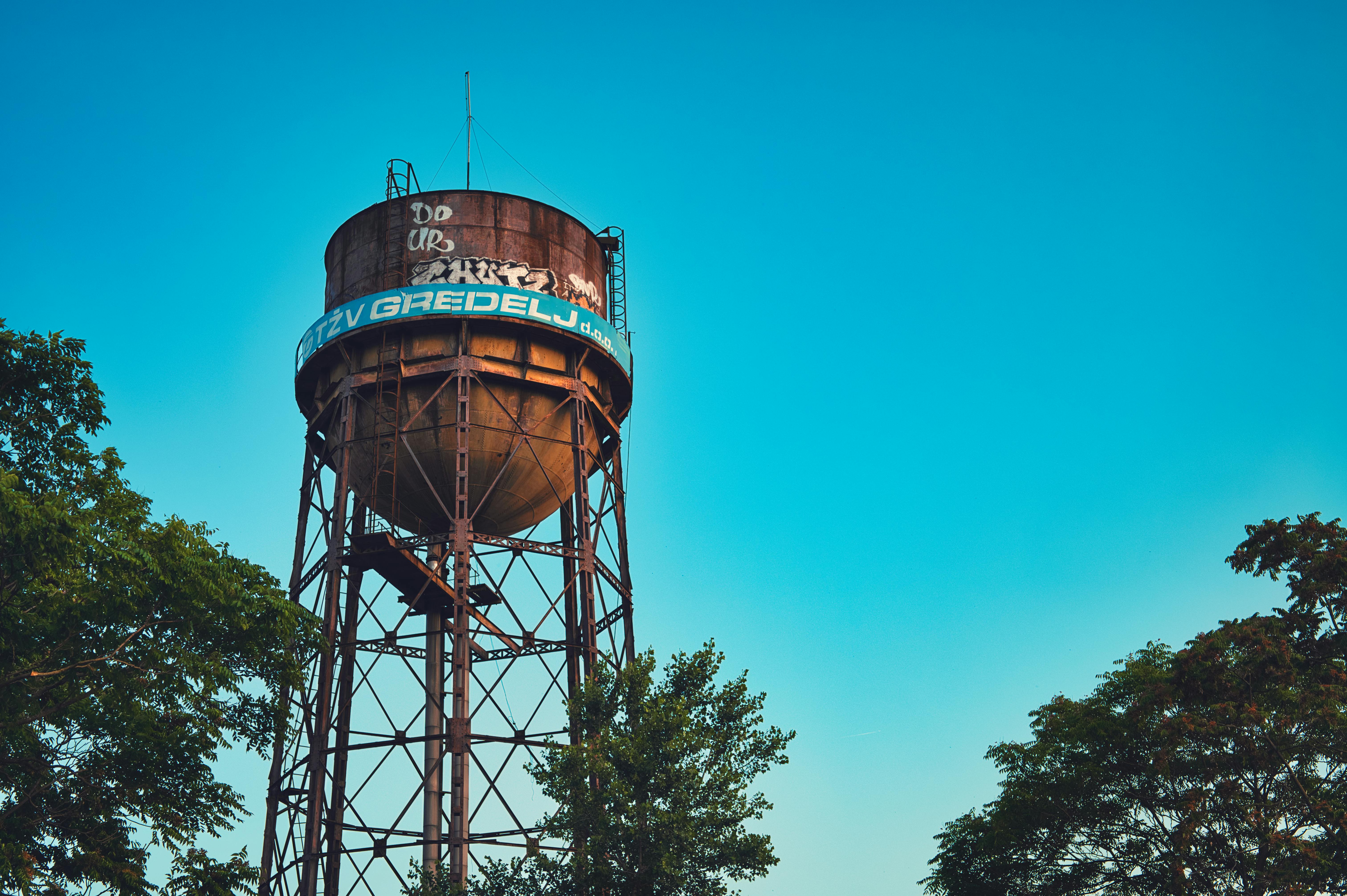 Industrial Water Tower Against Clear Blue Sky · Free Stock Photo