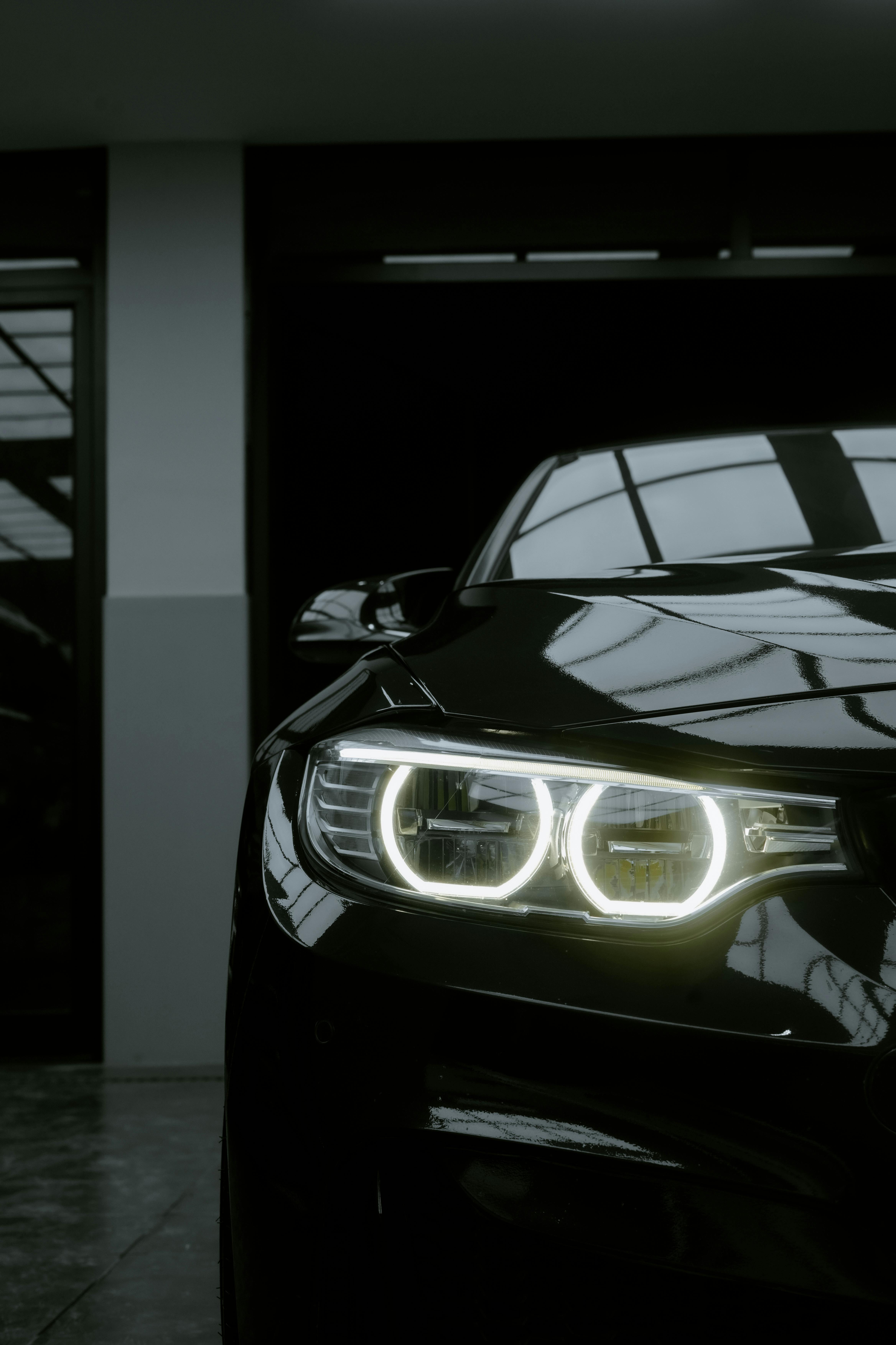 Elegant Black Car with Illuminated Headlights · Free Stock Photo