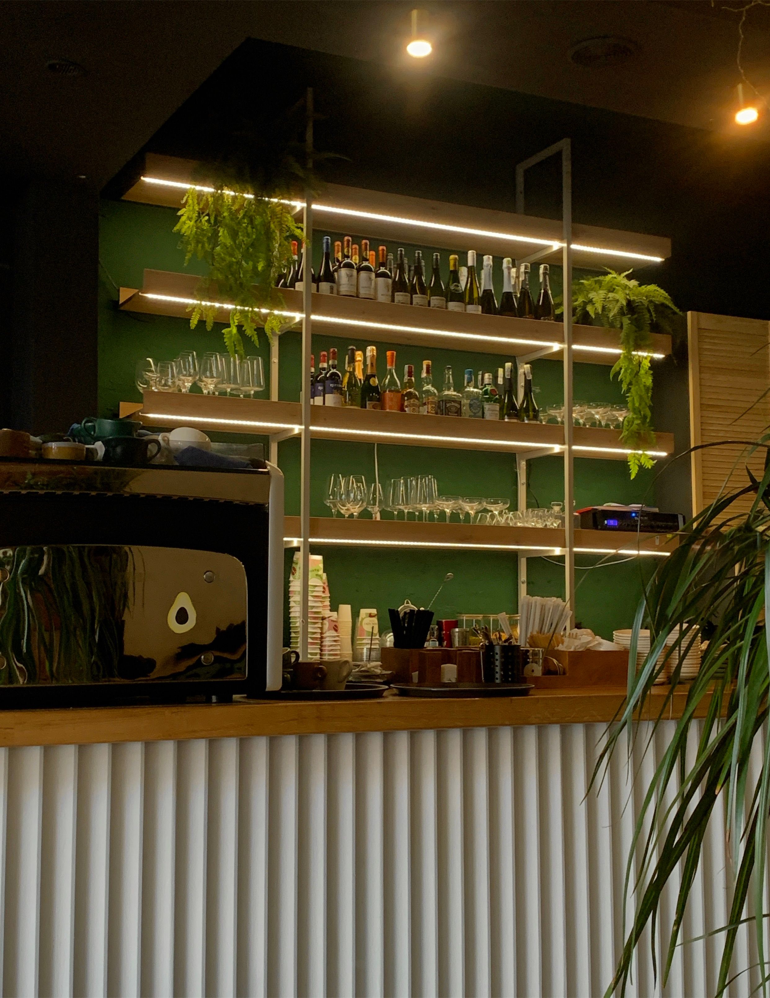 Chic Cafe Interior with Bar and Plants · Free Stock Photo