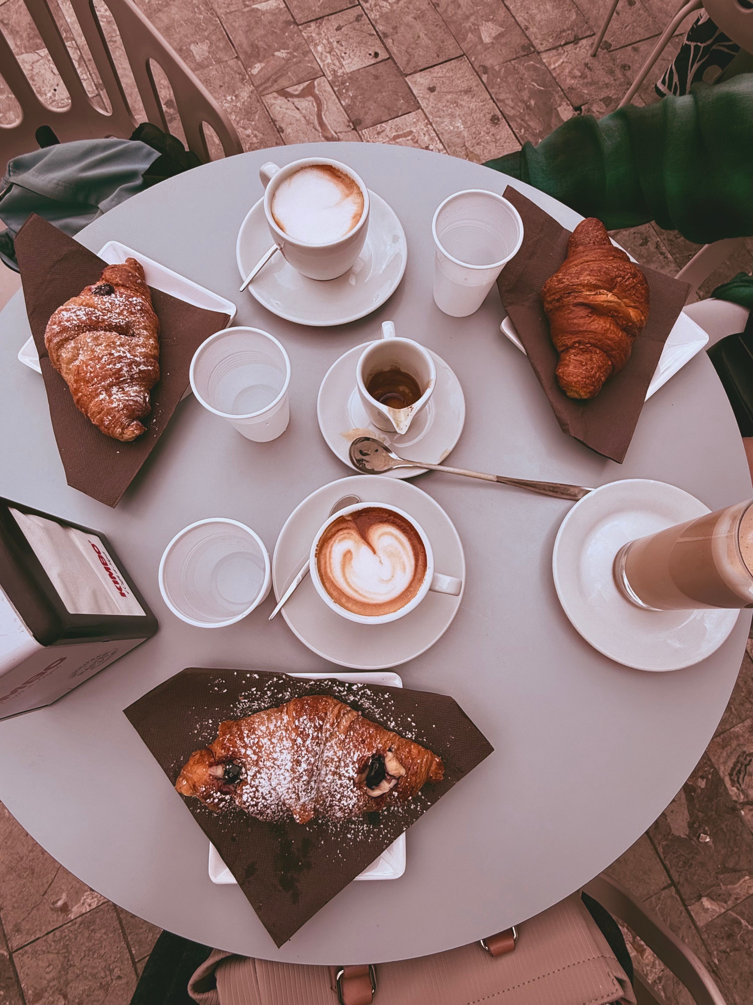 Cozy Coffee Break with Croissants and Cappuccinos · Free Stock Photo