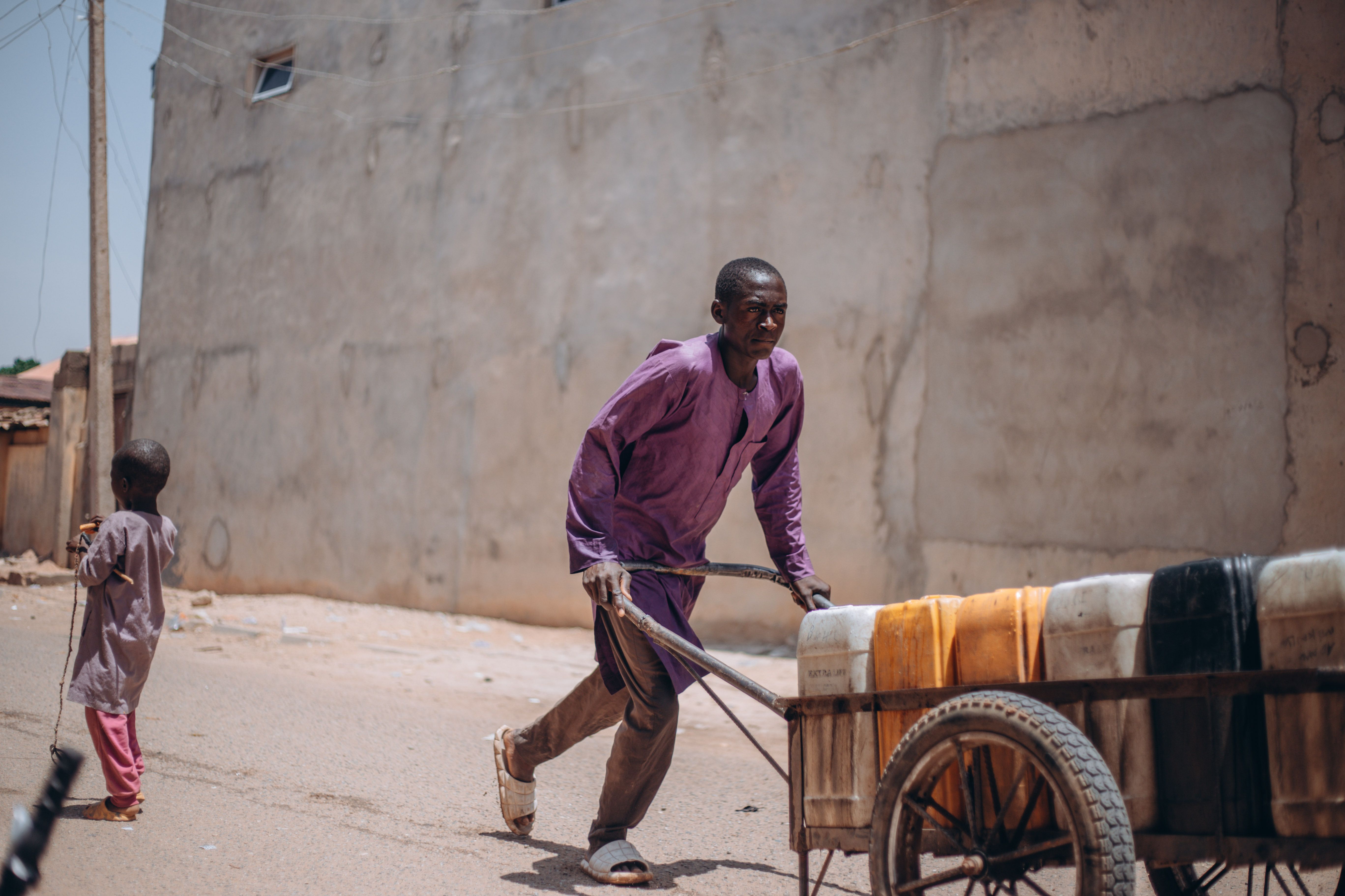 Street Scene with Man Pushing Cart · Free Stock Photo