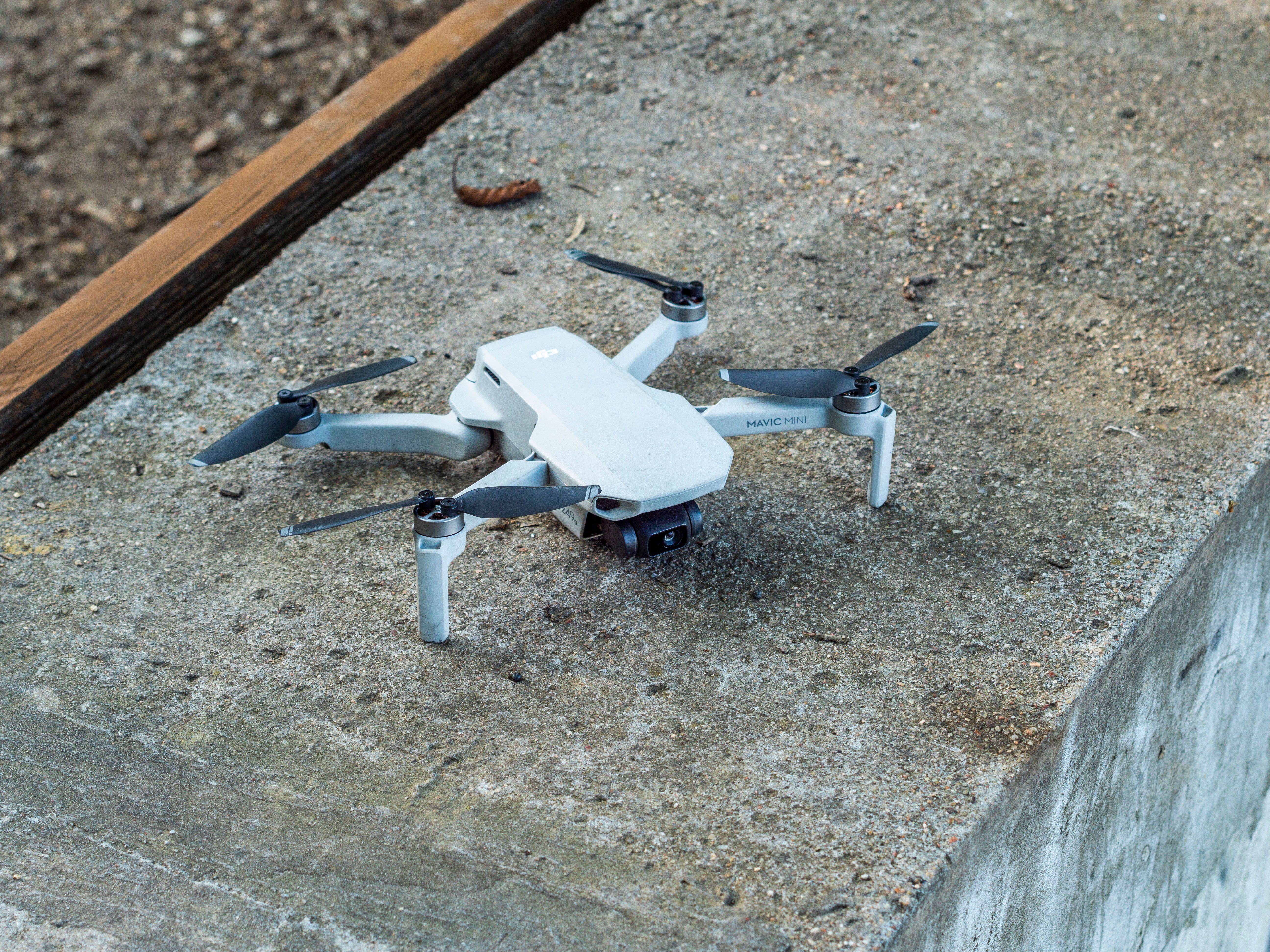 Compact Drone Resting on Concrete Surface · Free Stock Photo