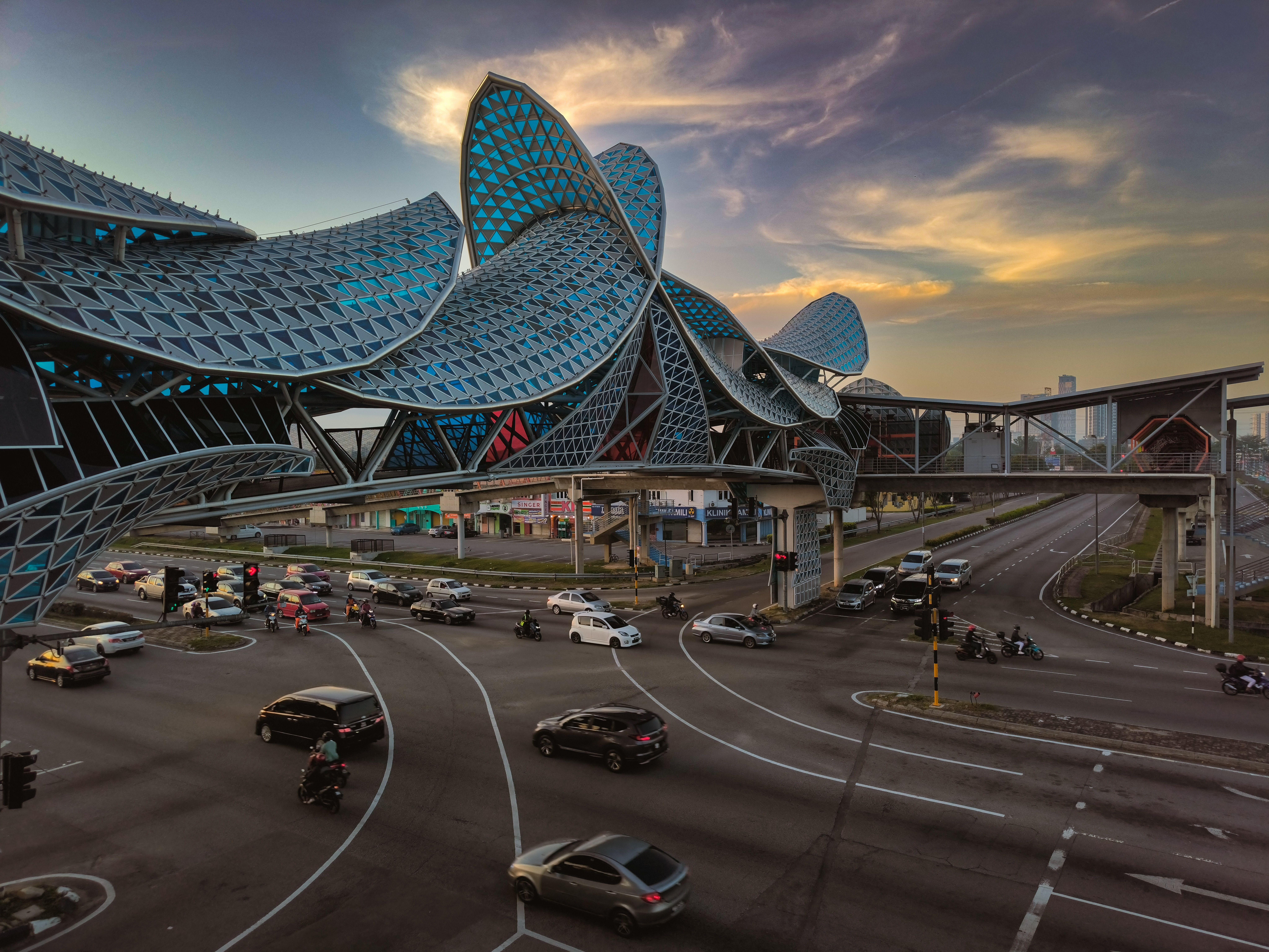 Modern Architectural Structure Above Busy Intersection · Free Stock Photo