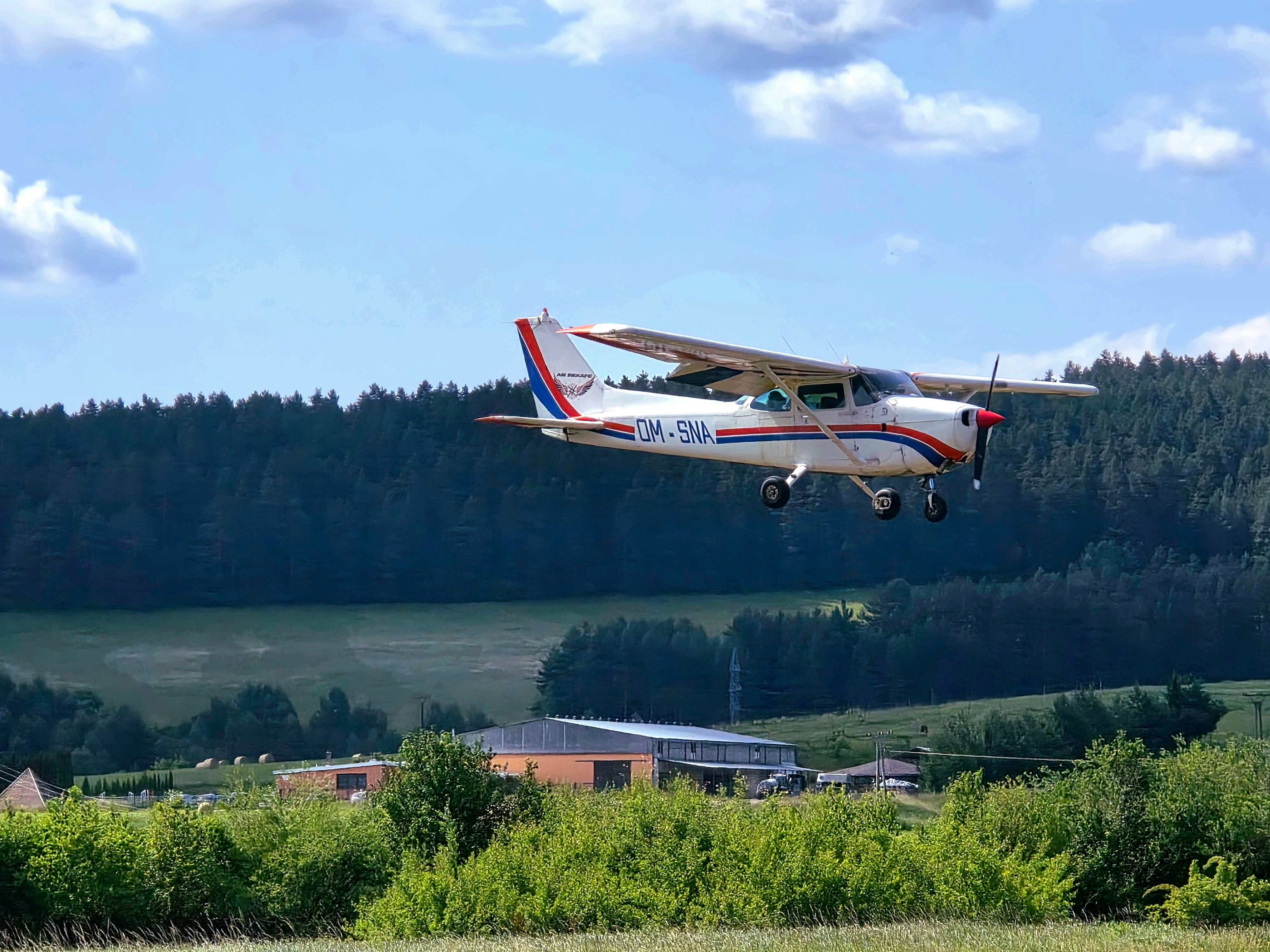 Light Aircraft Flying Over Scenic Countryside · Free Stock Photo