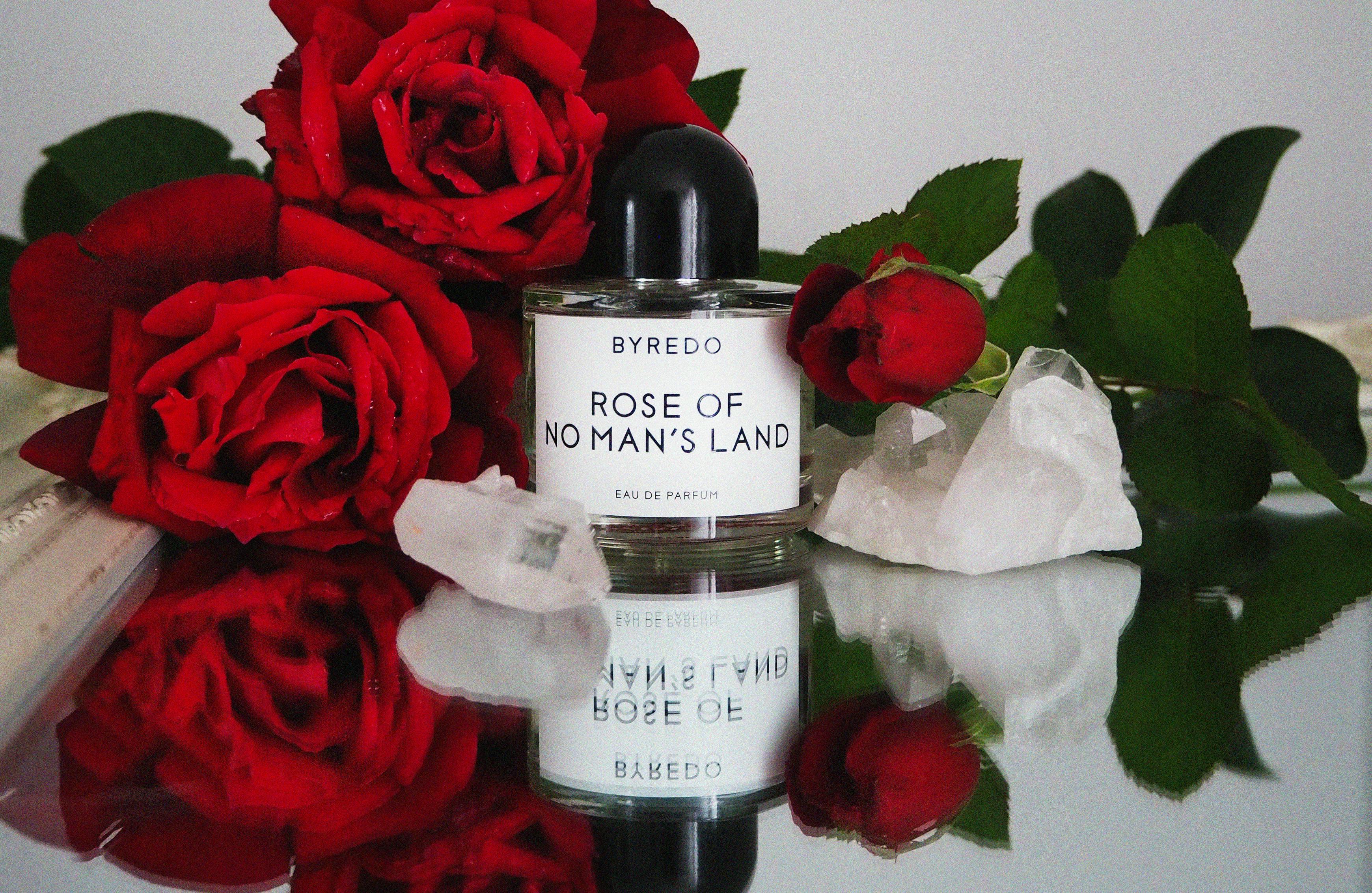 Luxurious Byredo Perfume with Red Roses and Quartz · Free Stock Photo