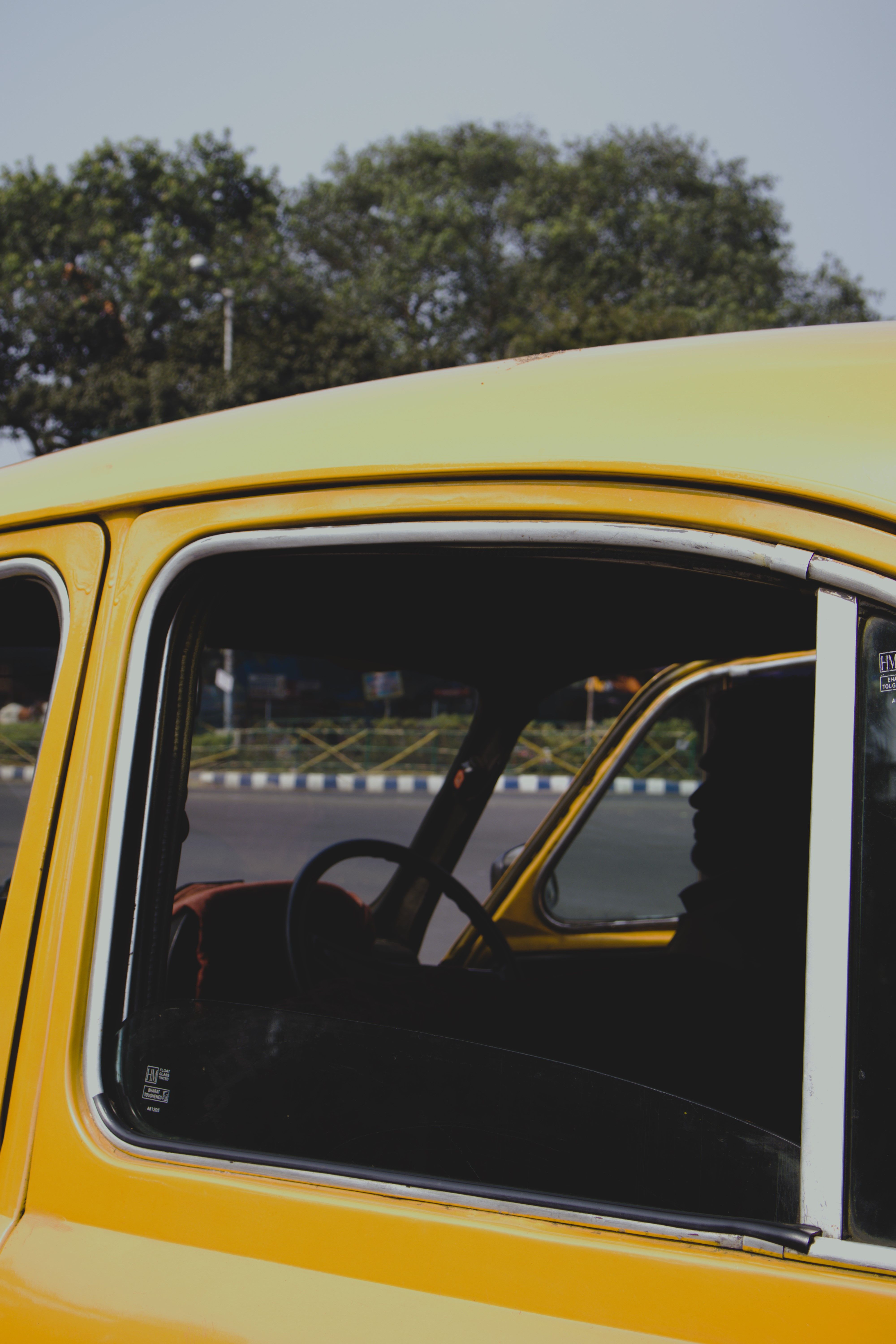 Classic Yellow Car in Urban Street Scene · Free Stock Photo