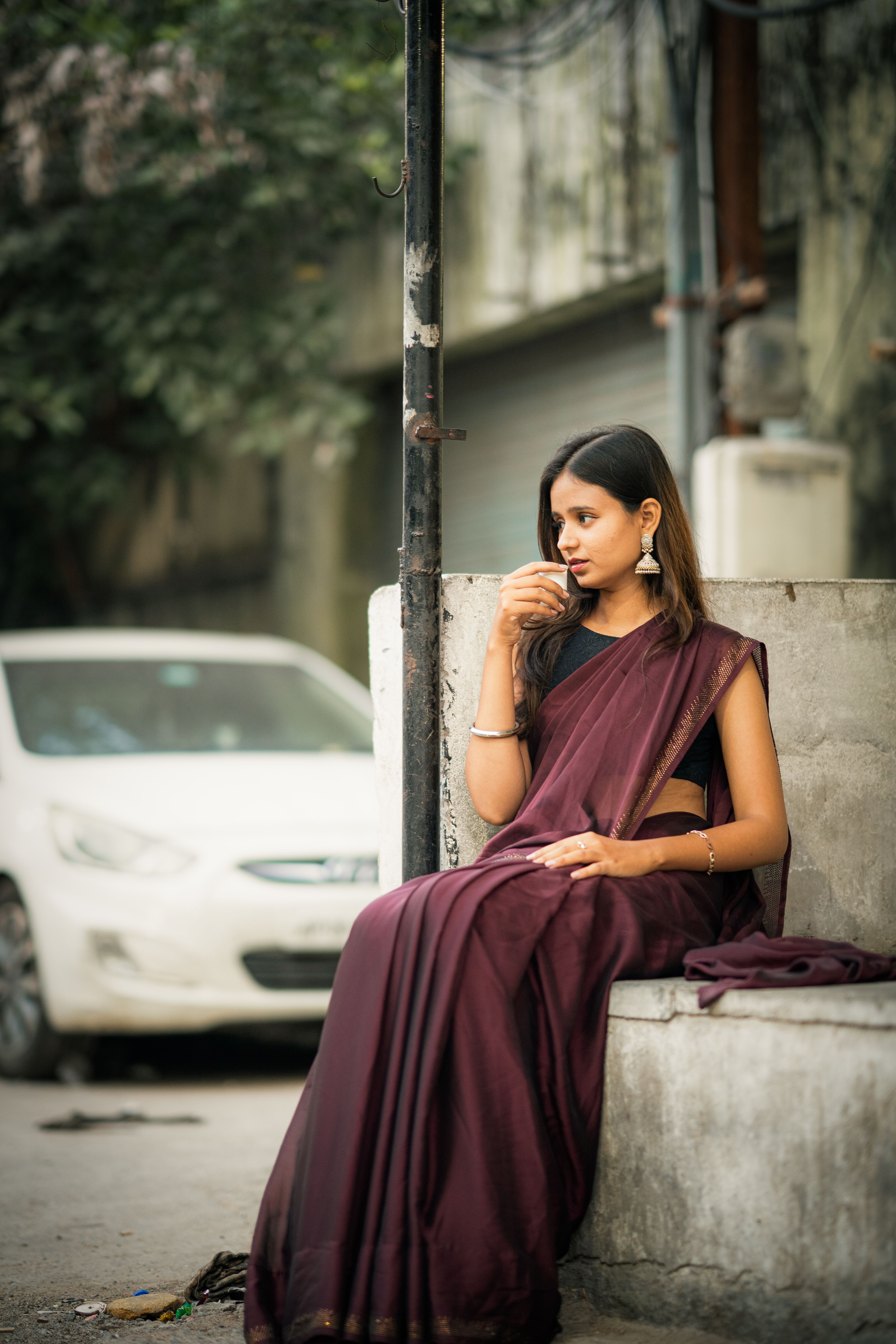 Elegant Woman in a Purple Saree on Urban Street · Free Stock Photo