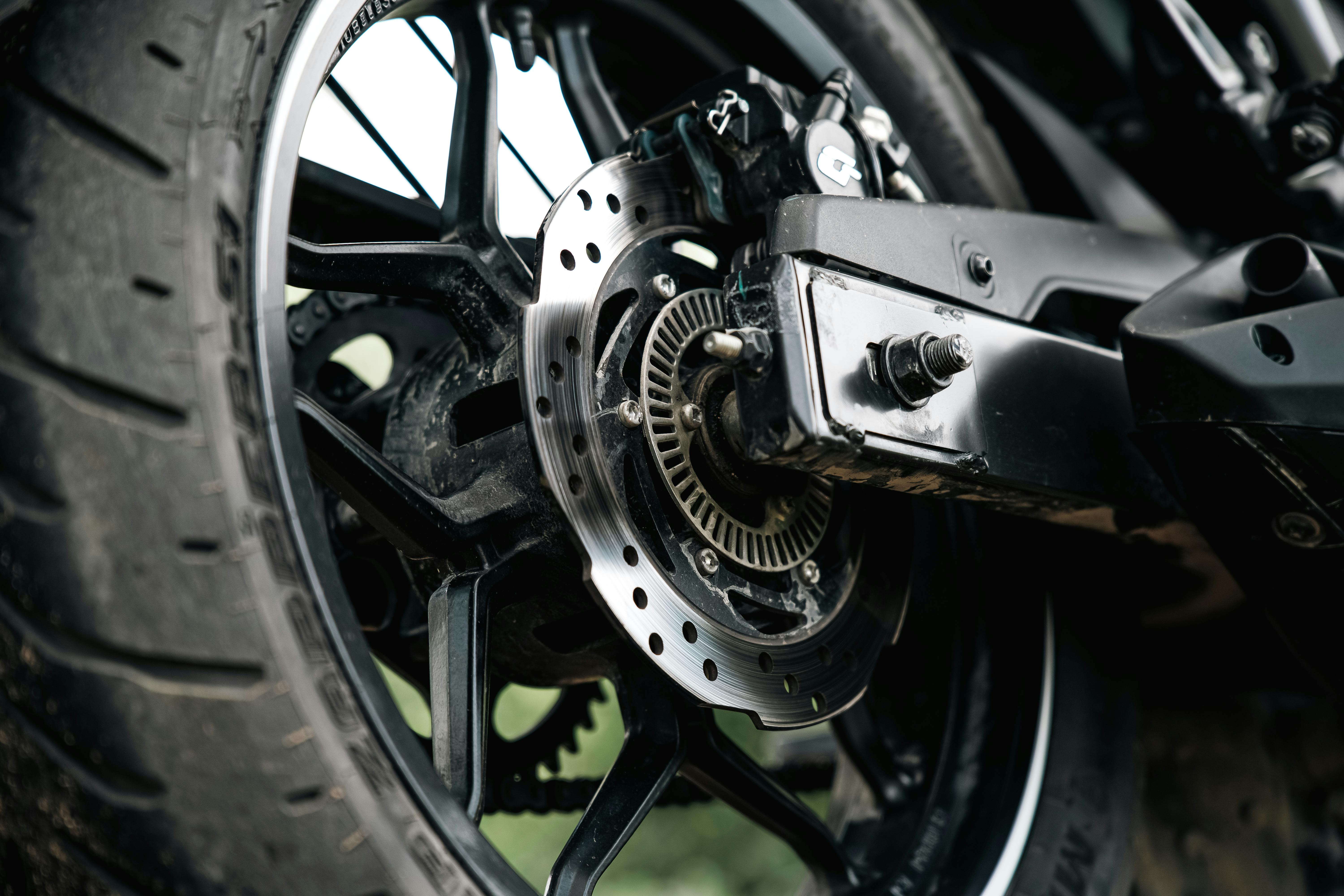 Close-Up of Motorcycle Rear Wheel with Disc Brake · Free Stock Photo