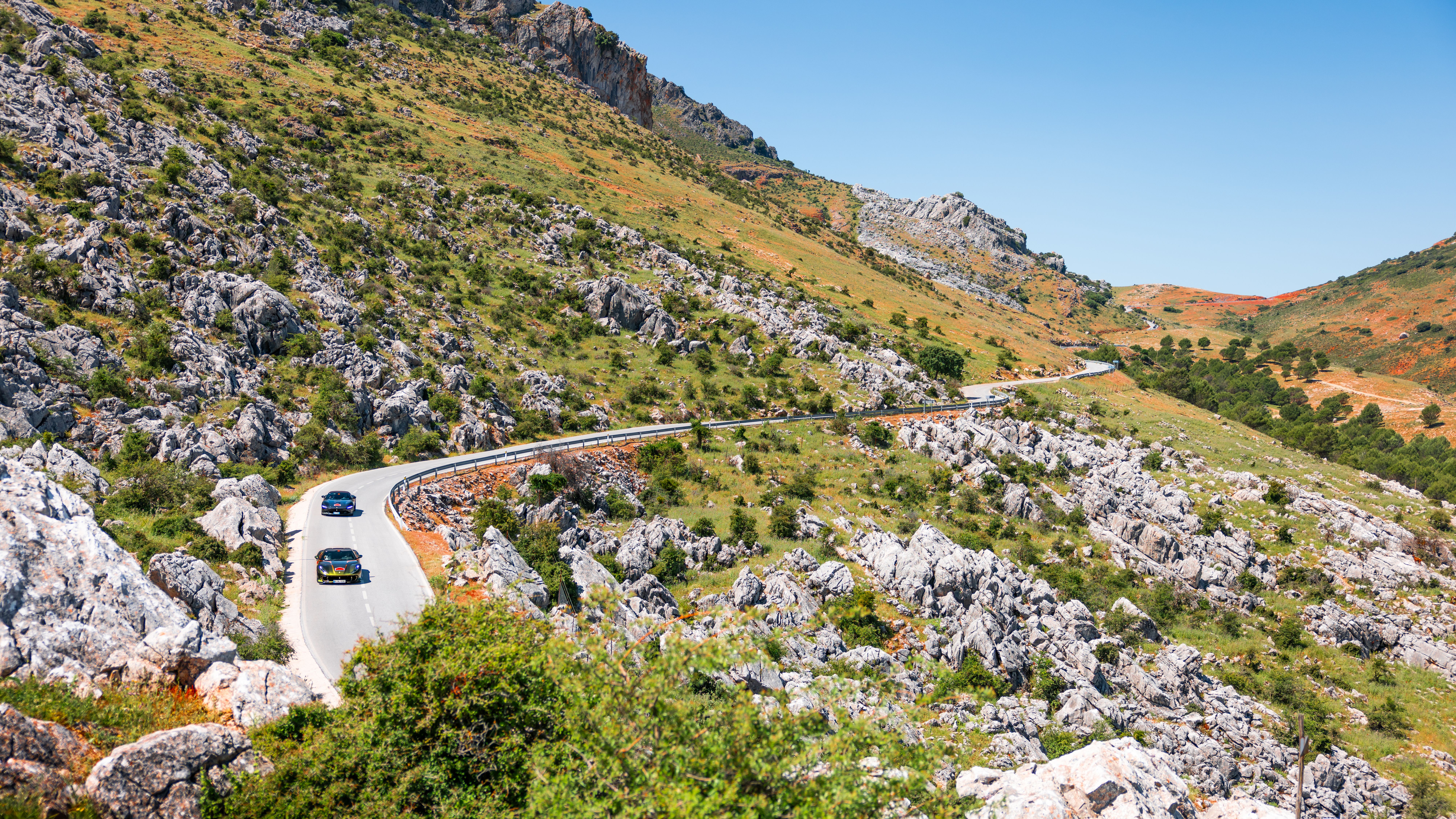 Scenic Mountain Road with Cars on a Sunny Day · Free Stock Photo