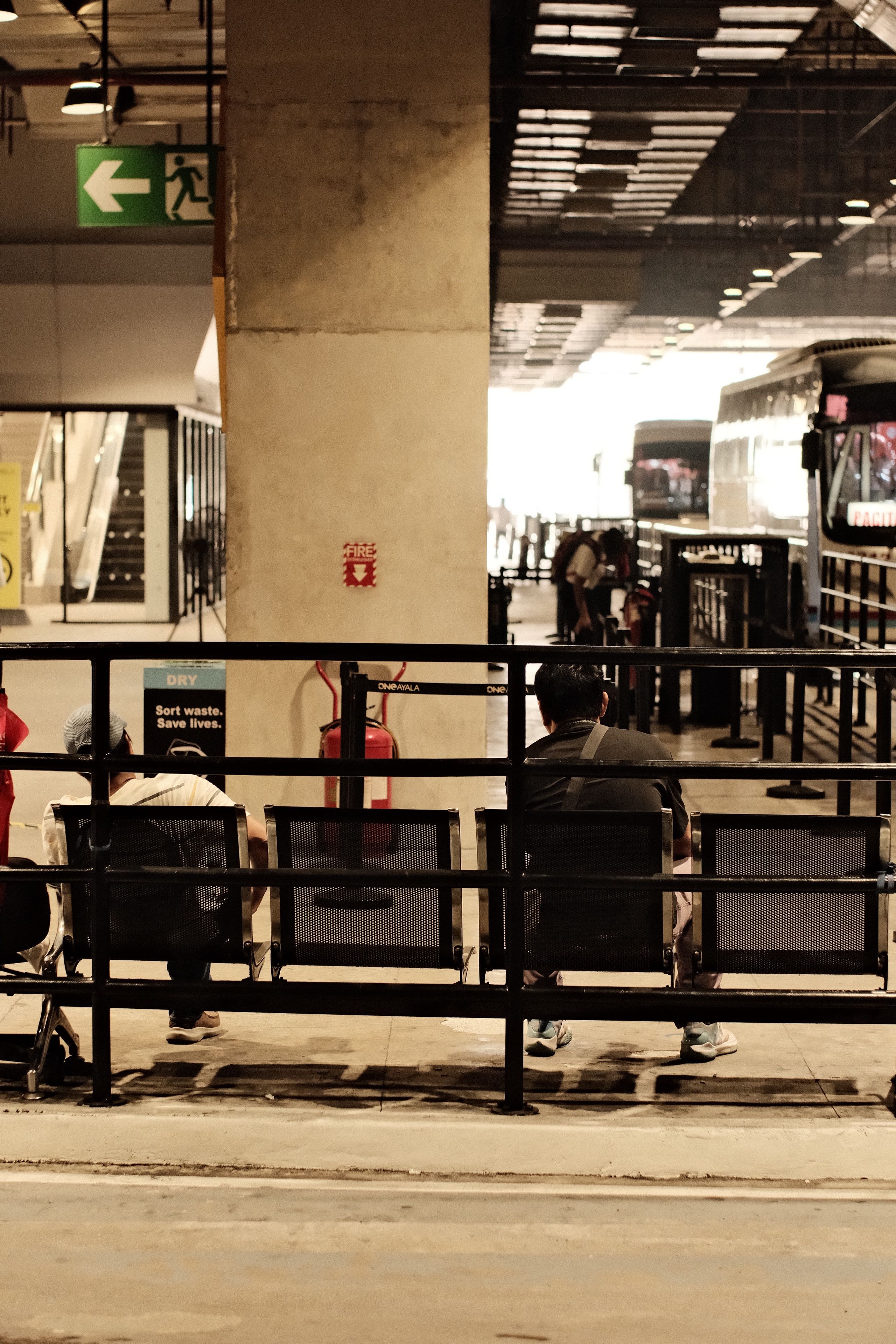 People Sitting in Bus Station Waiting Area · Free Stock Photo