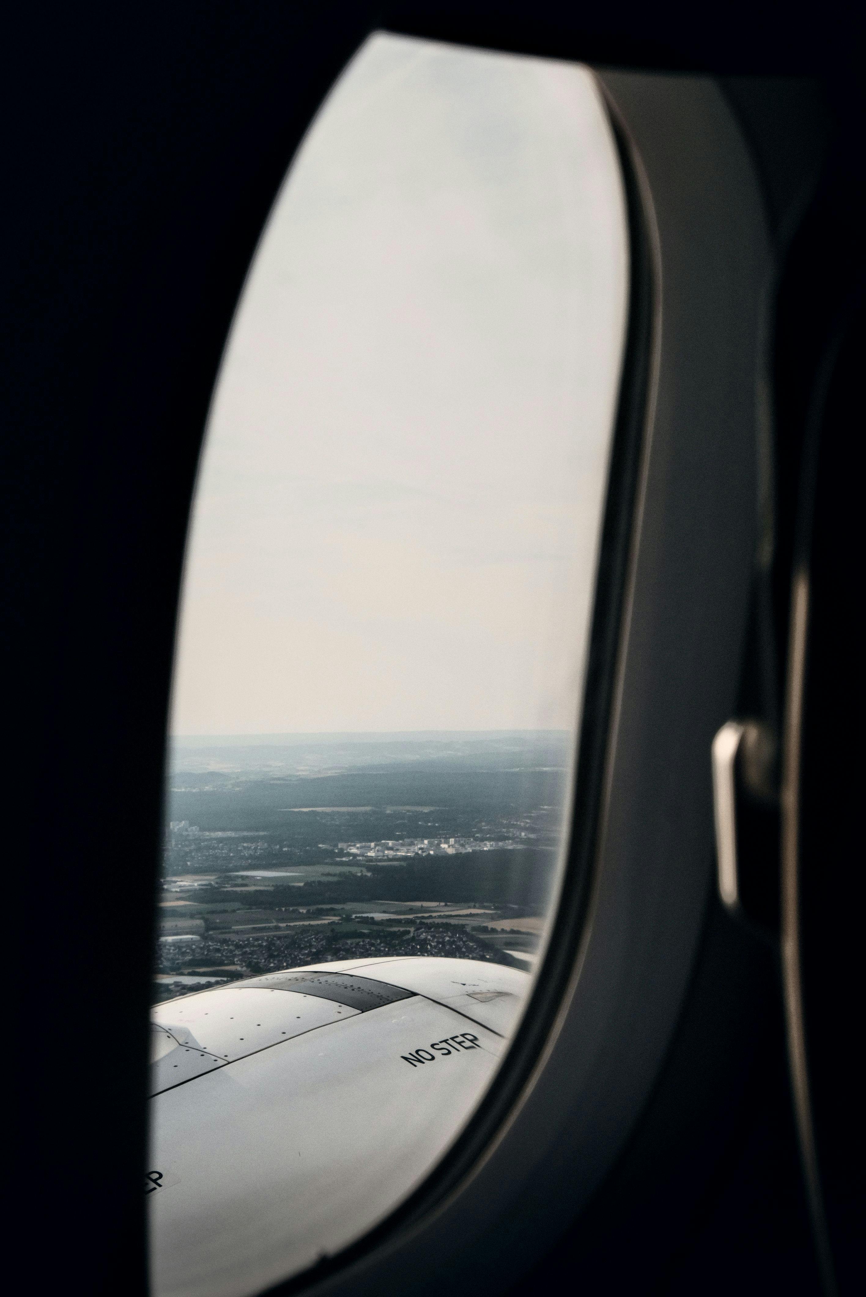 Scenic Aerial View Through Airplane Window · Free Stock Photo