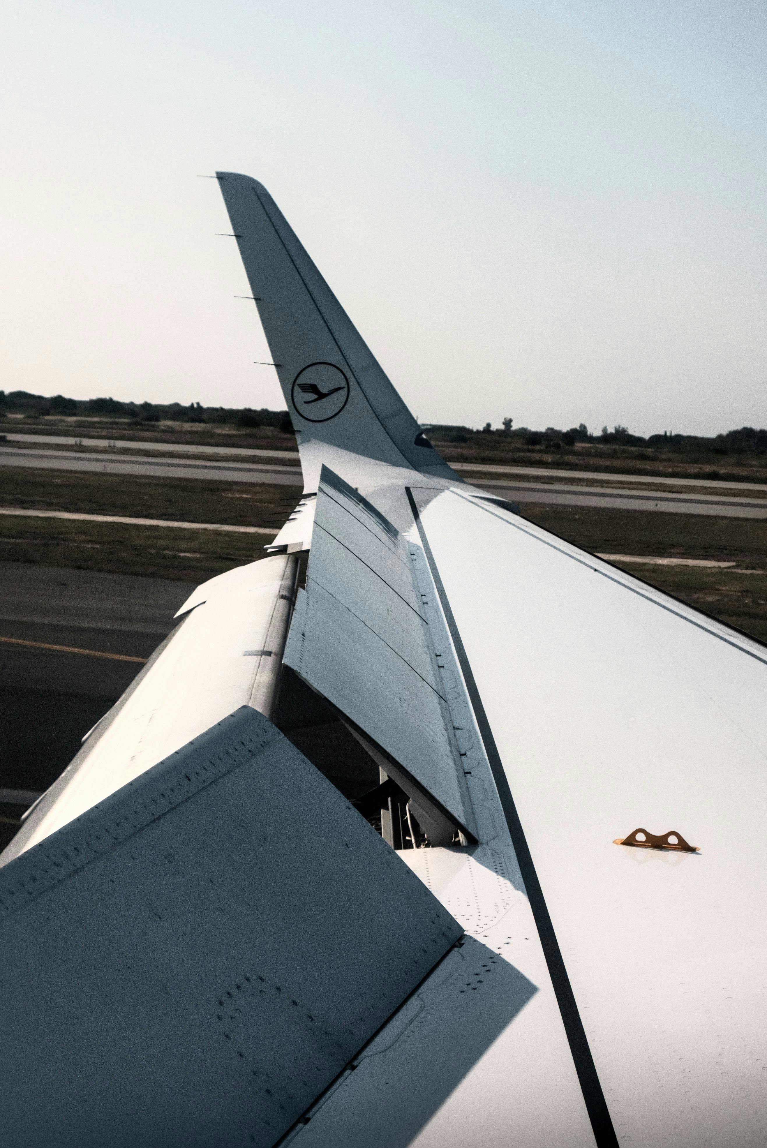 Airplane Wing and Flaps During Flight at Airport · Free Stock Photo