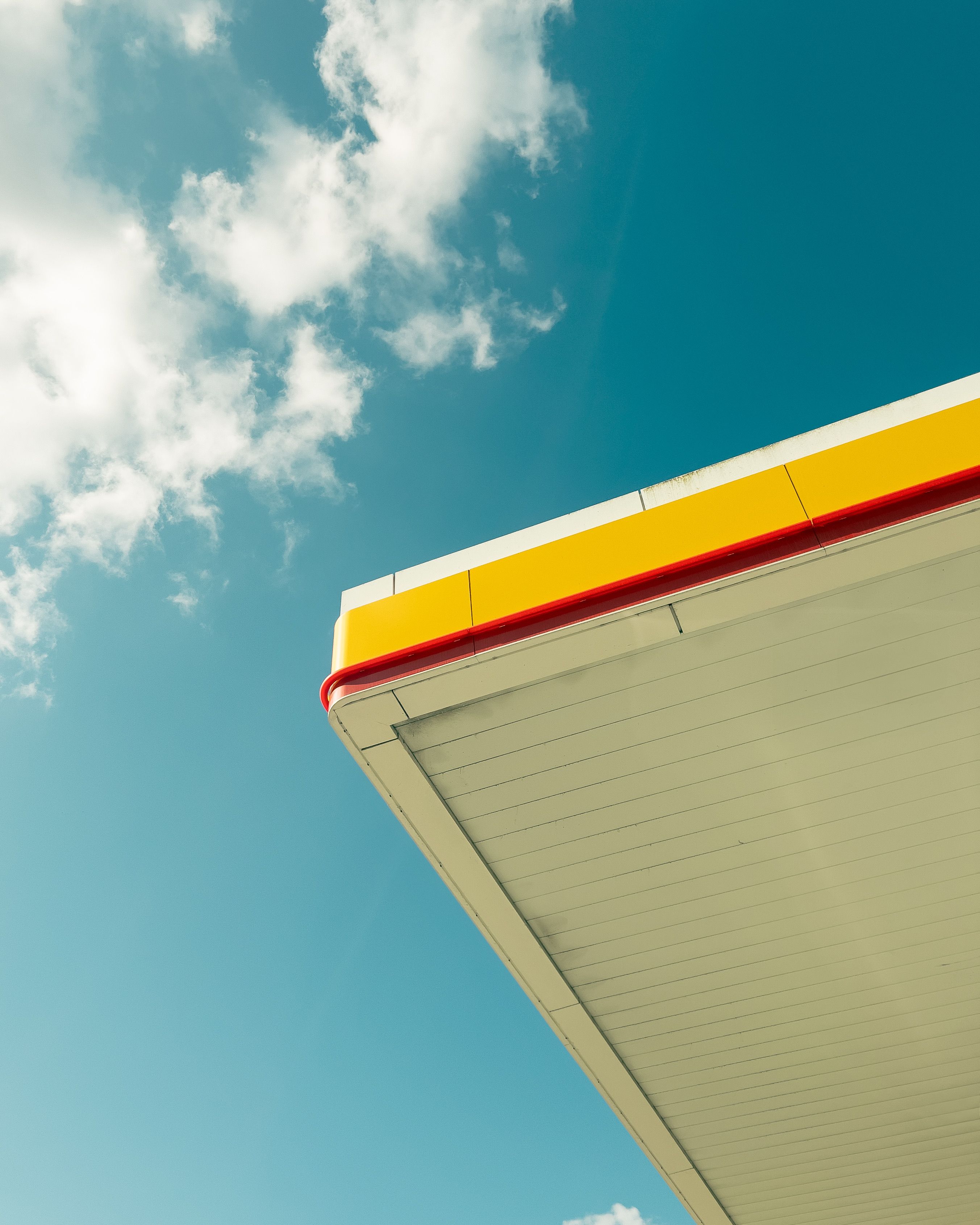 Modern Gas Station Canopy Against Blue Sky · Free Stock Photo