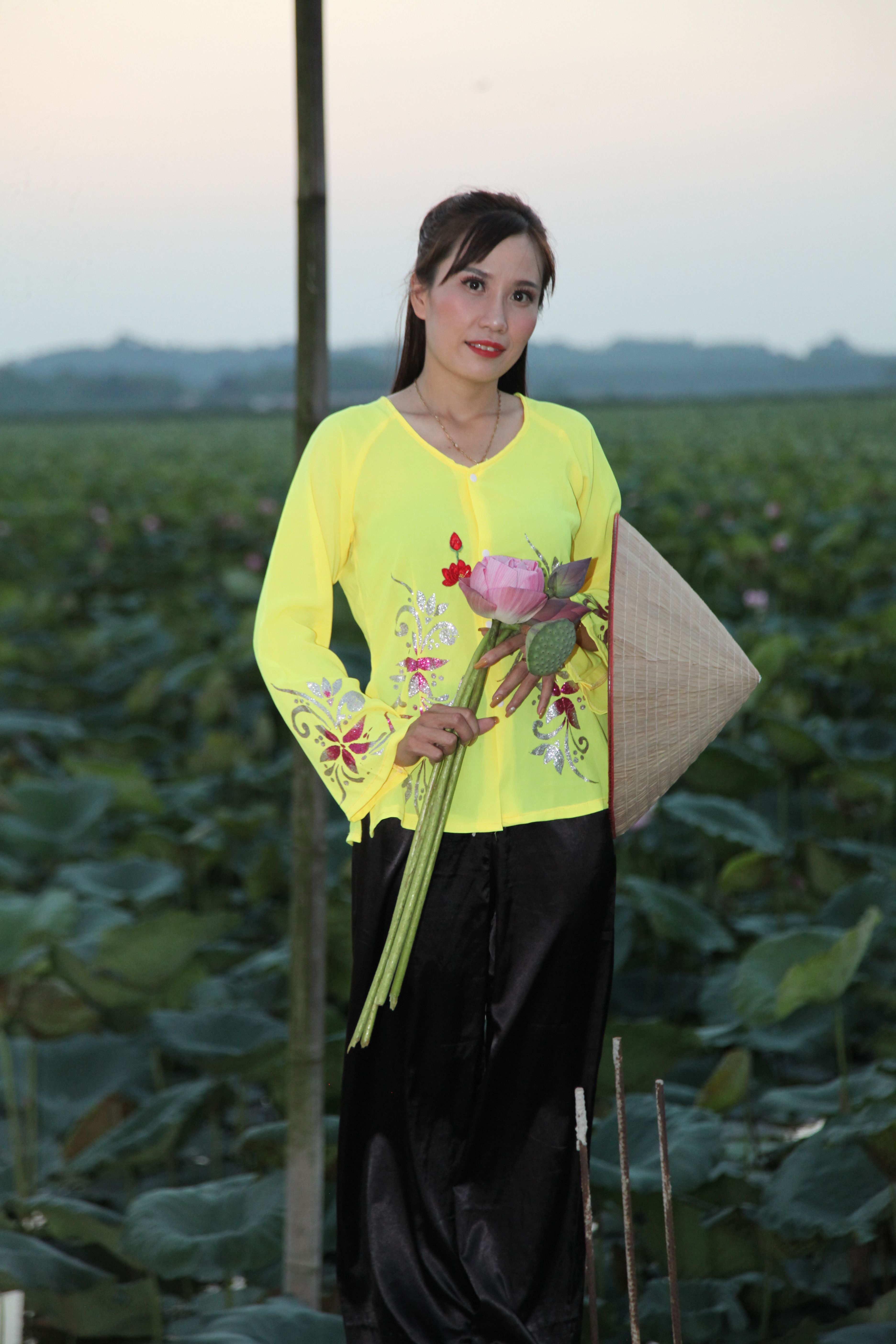 Woman Holding Lotus Flowers in Traditional Dress · Free Stock Photo