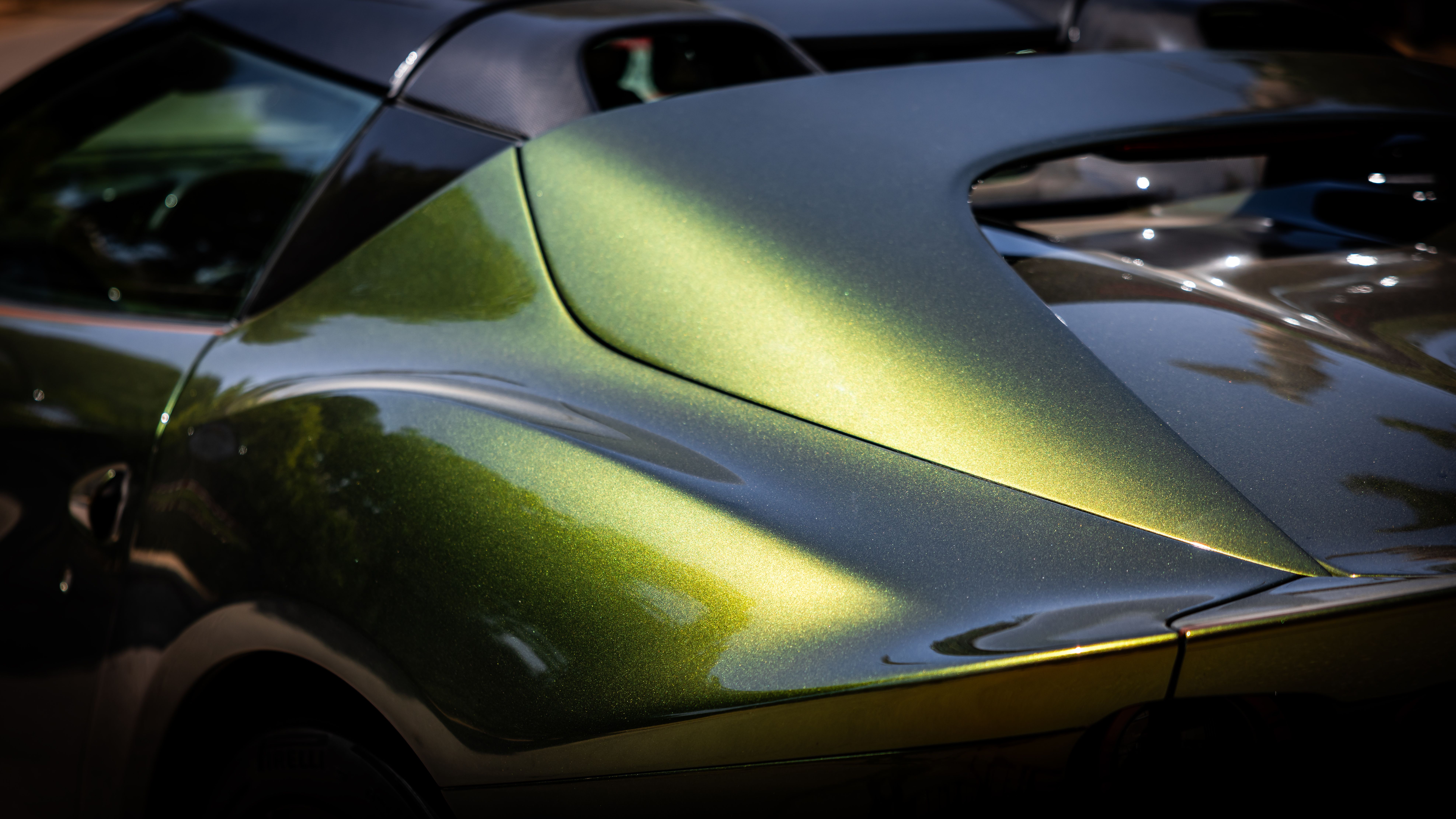 Close-up of Stylish Green Sports Car in Sunlight · Free Stock Photo