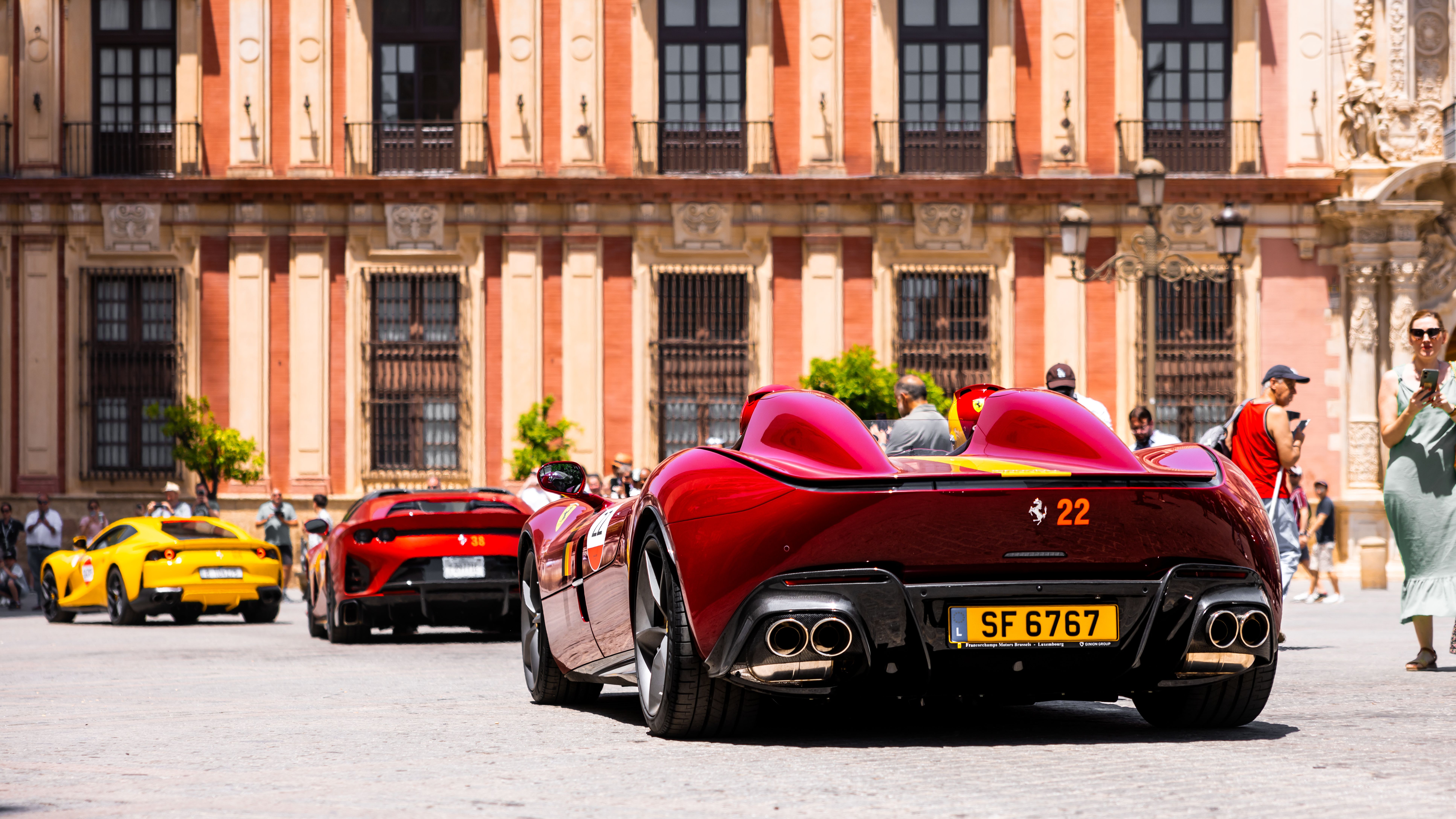 Luxury Sports Cars Parade in Historic Plaza · Free Stock Photo