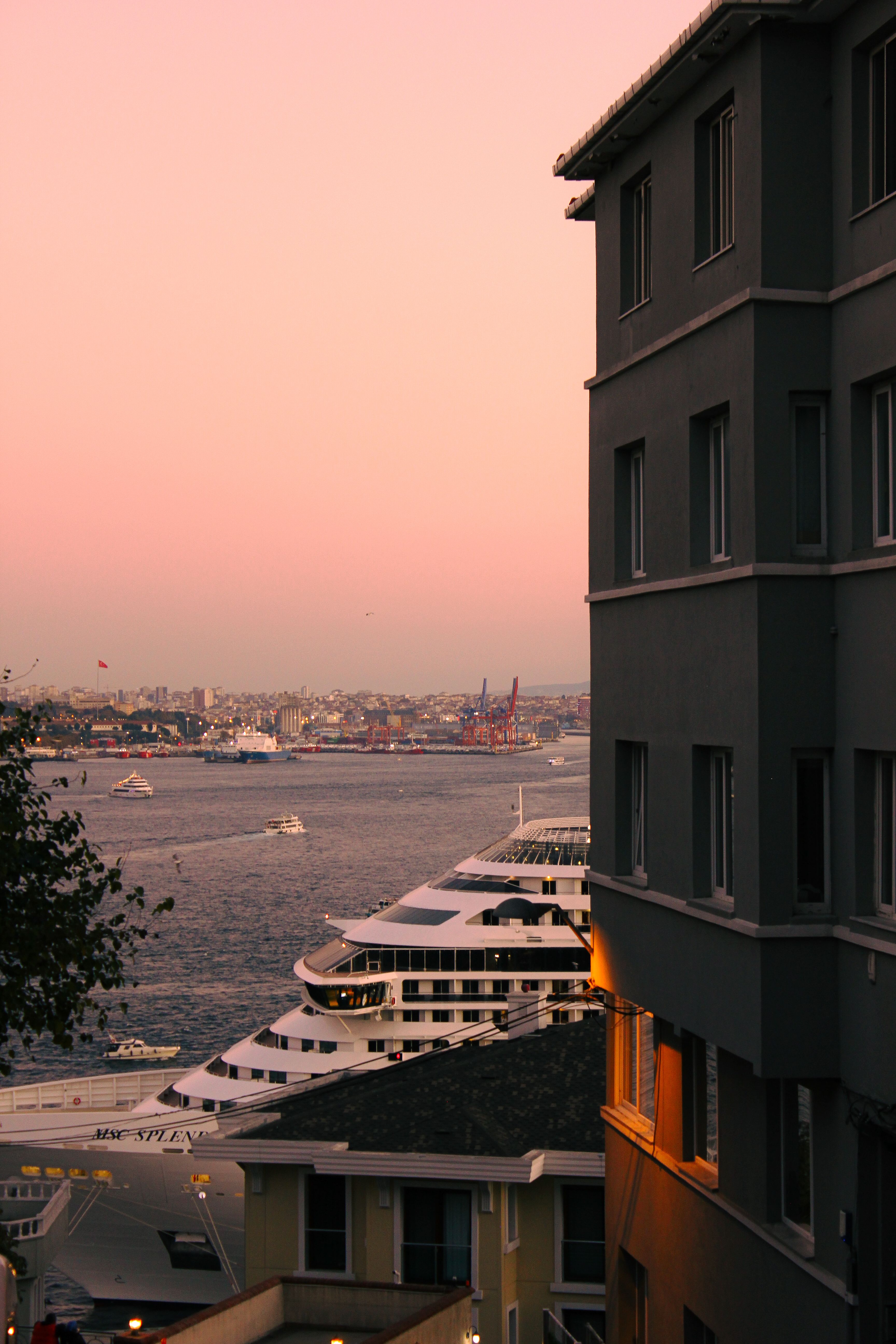 Scenic Harbor View with Cruise Ship at Sunset · Free Stock Photo