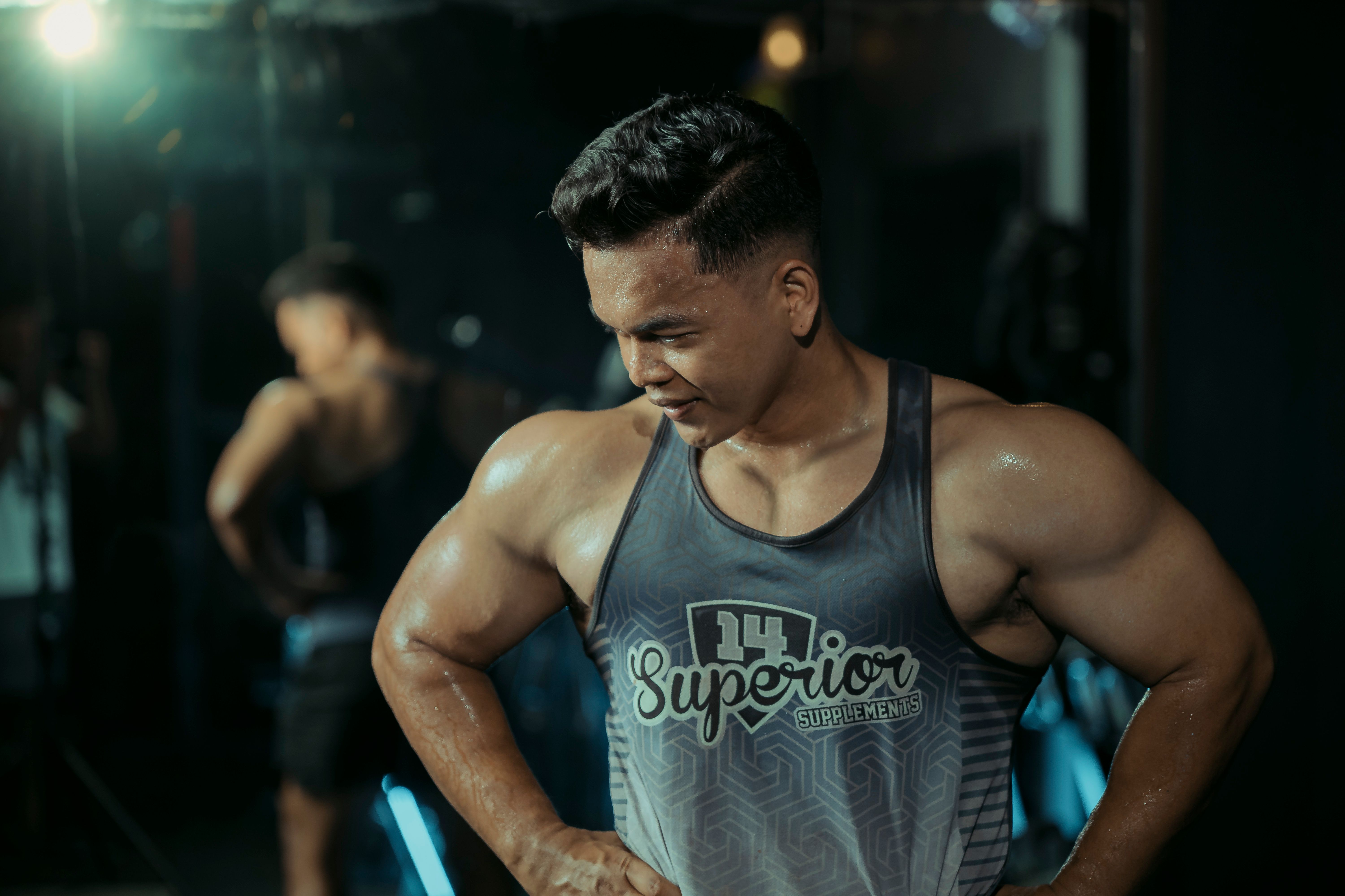 Athletic Man in Gym Poses with Confidence · Free Stock Photo