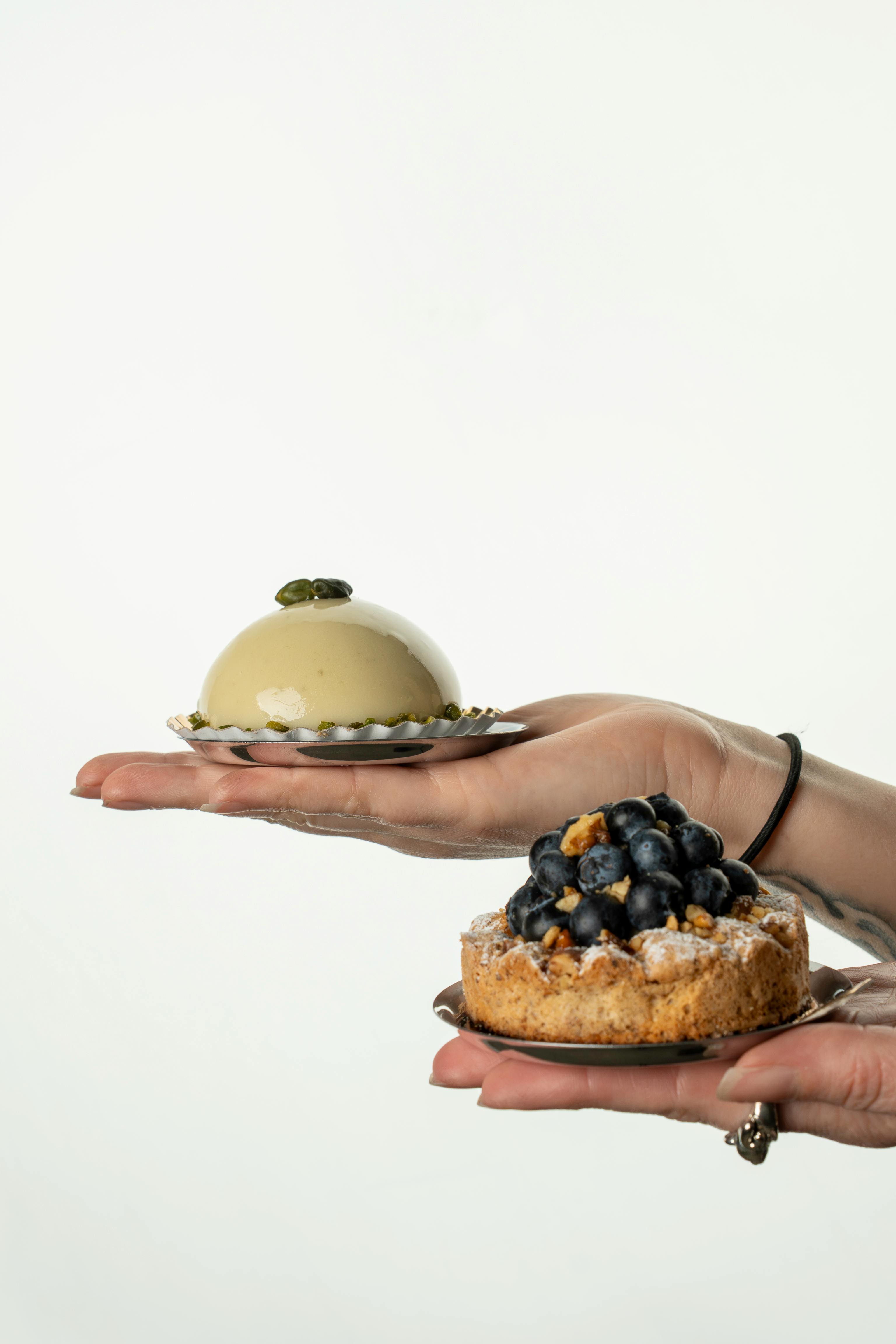 Elegant French Pastries Displayed on Hand · Free Stock Photo