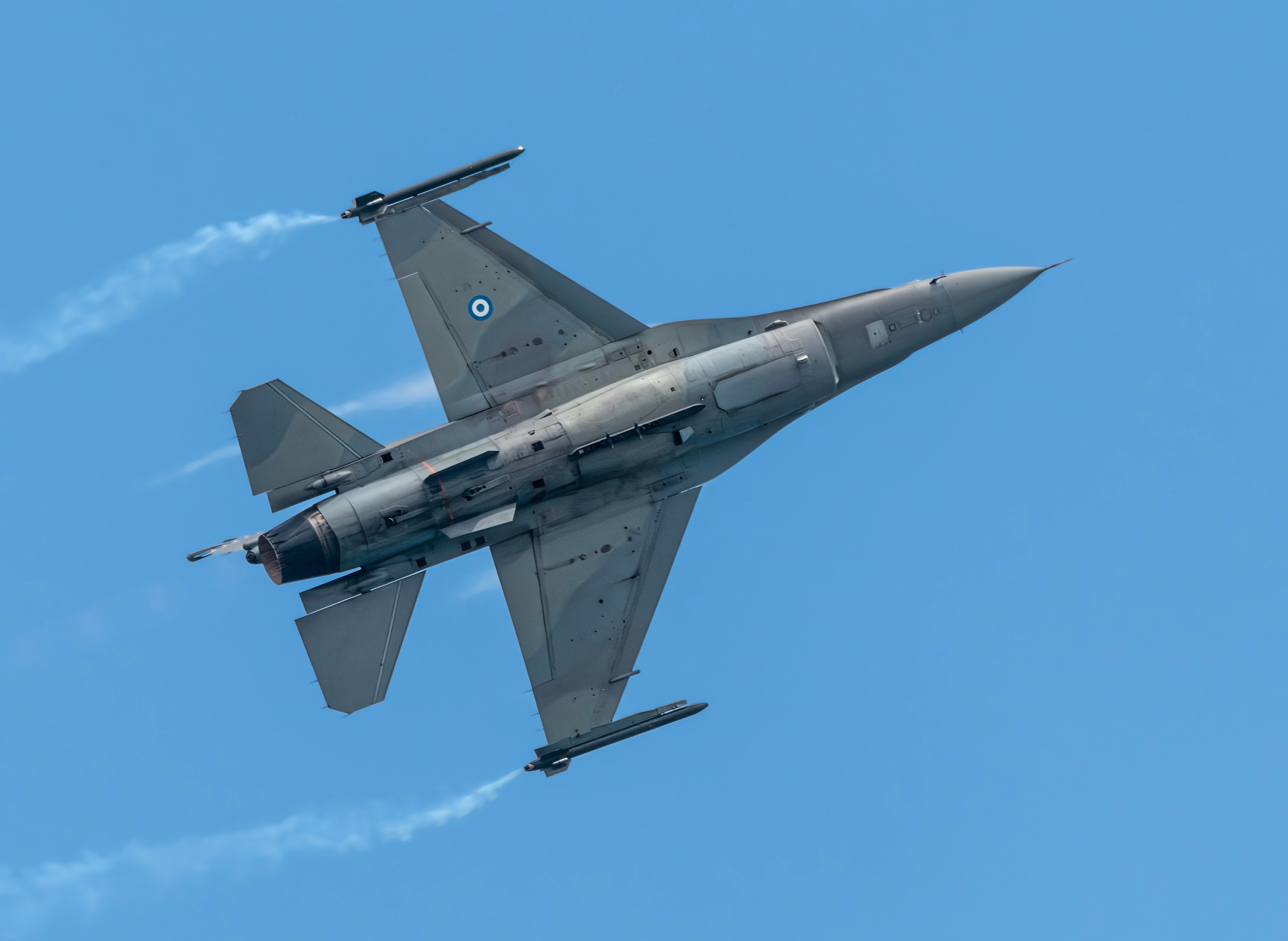 F-16 Fighter Jet in Flight Against Blue Sky · Free Stock Photo