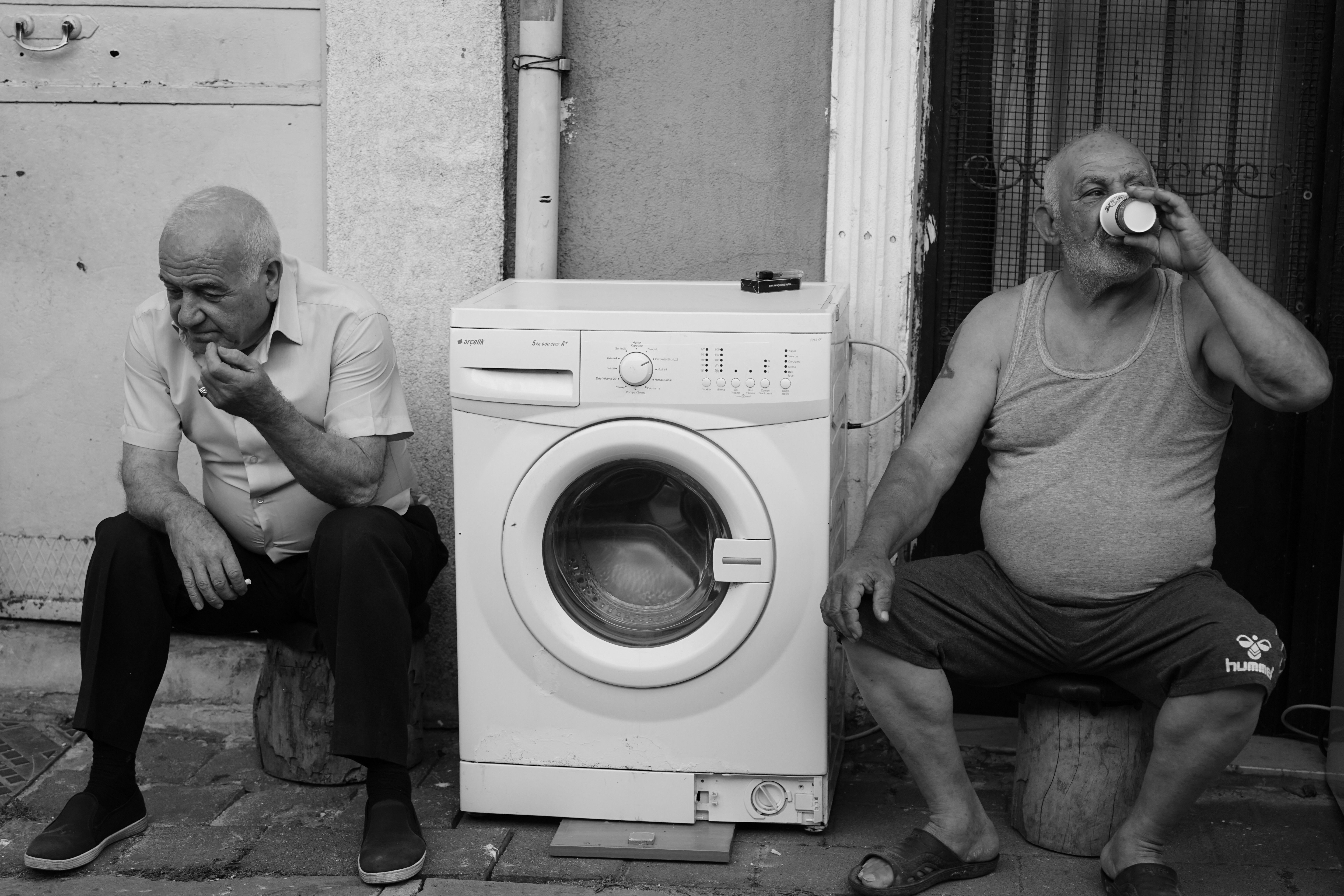 Two Elderly Men Sitting Next to Washing Machine · Free Stock Photo