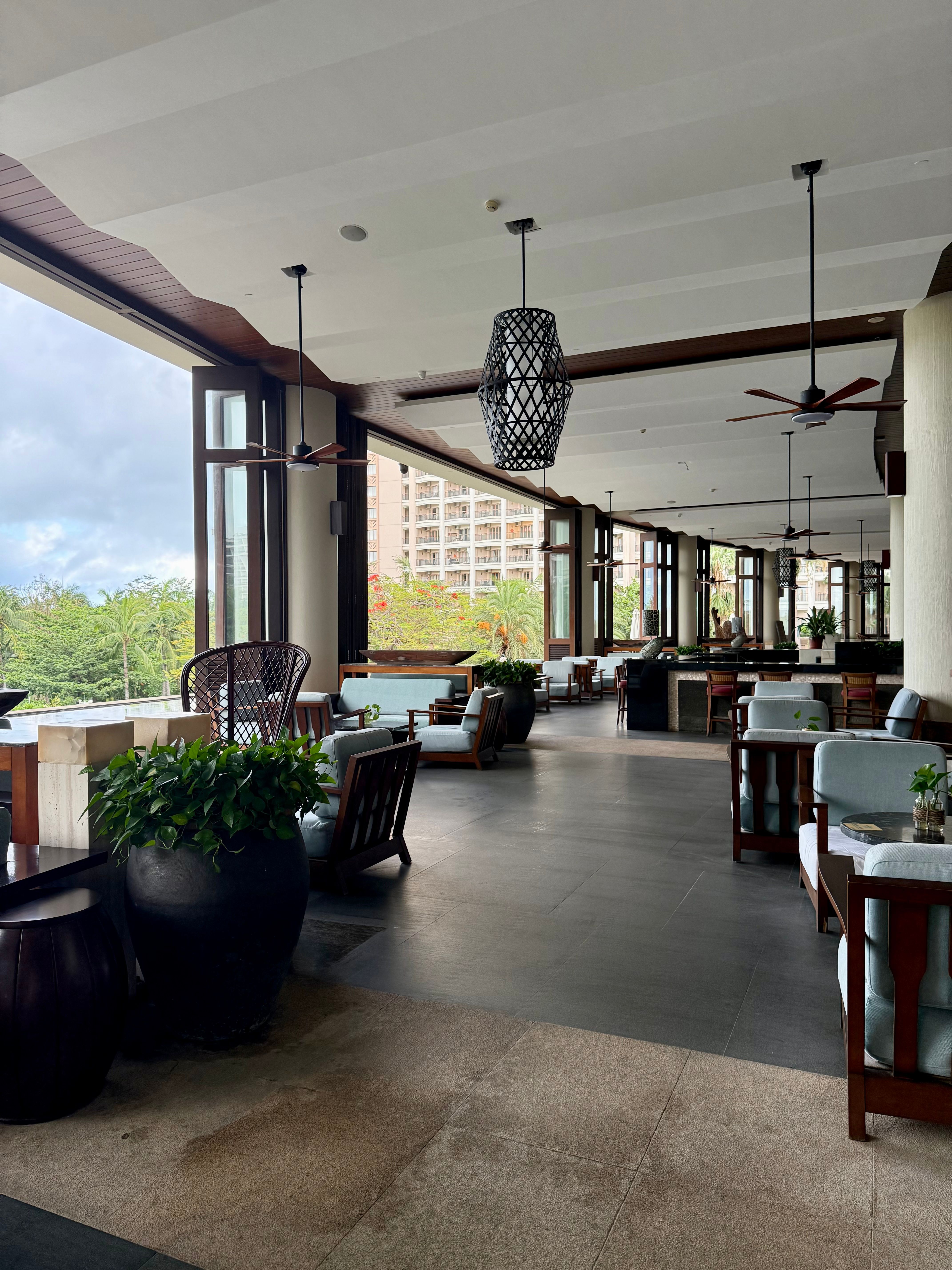 Modern Outdoor Hotel Lounge with Greenery View · Free Stock Photo