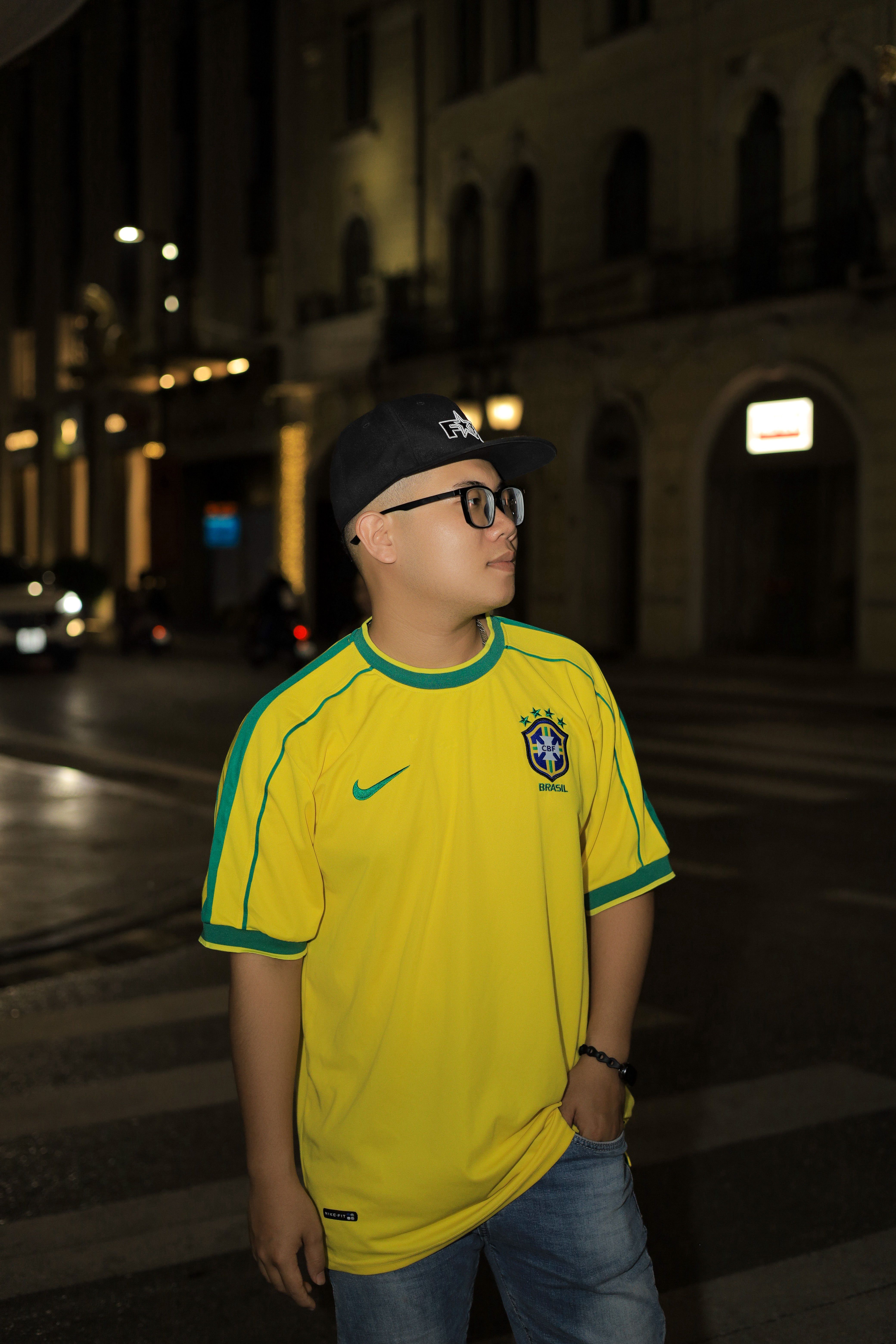 Young Man in Brazil Football Shirt at Night in Hanoi · Free Stock Photo