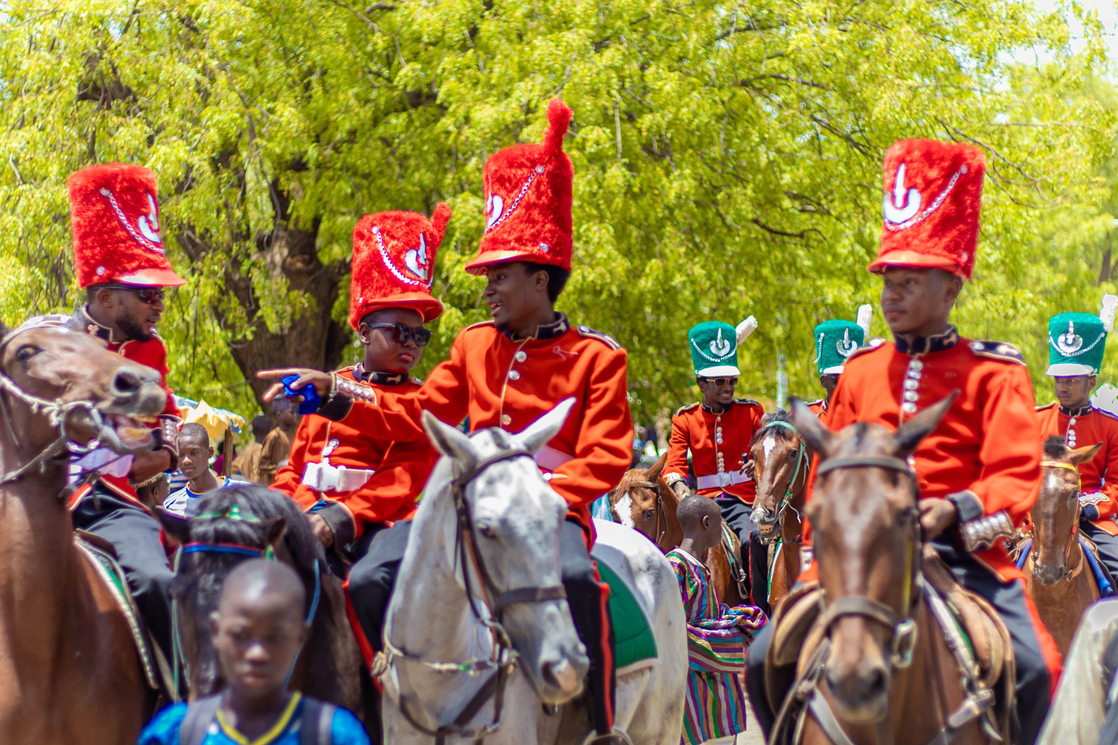 Vibrant Parade with Equestrian Performers in Red Uniforms · Free Stock ...
