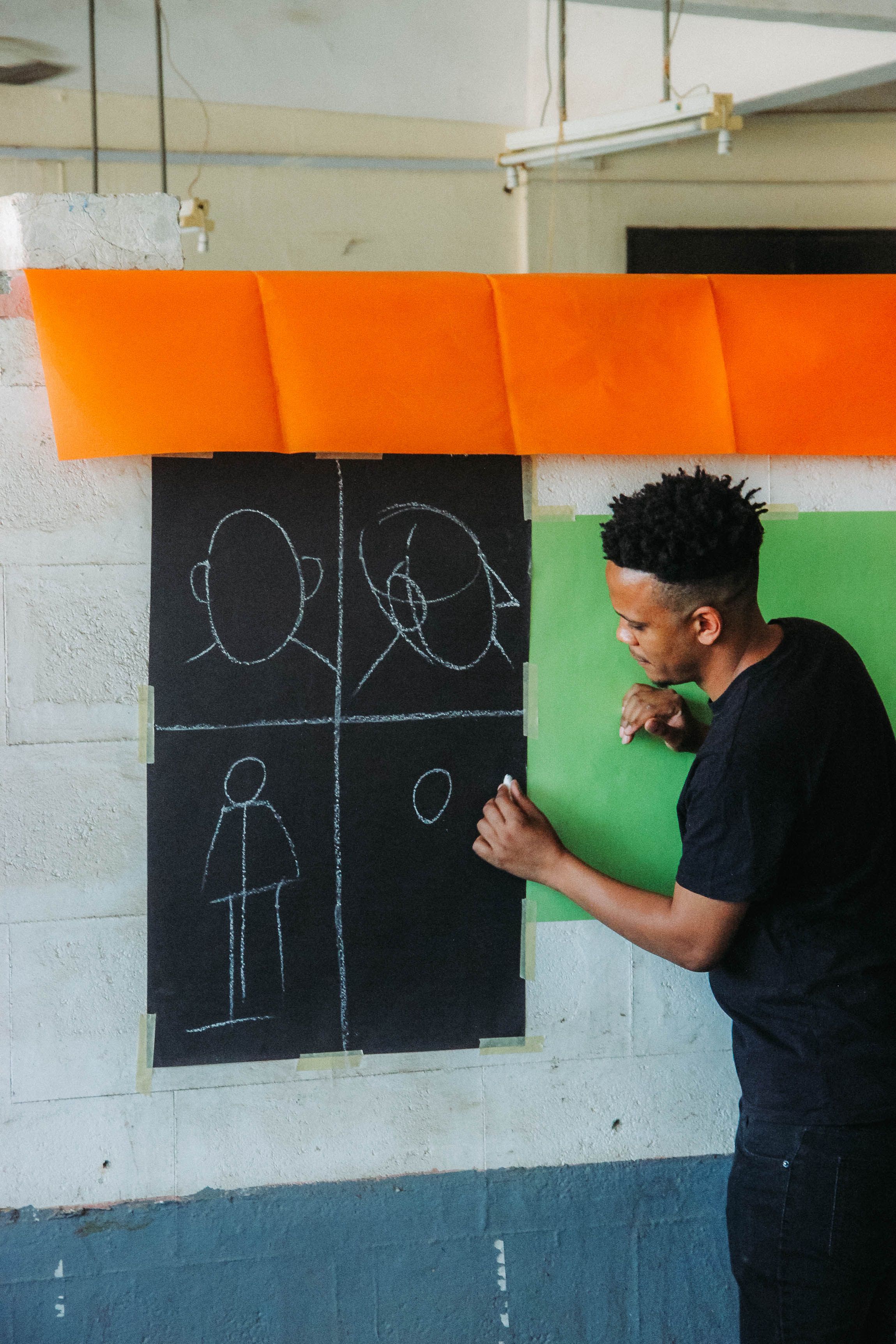 Artist Creating Chalk Drawings on Blackboard Indoors · Free Stock Photo