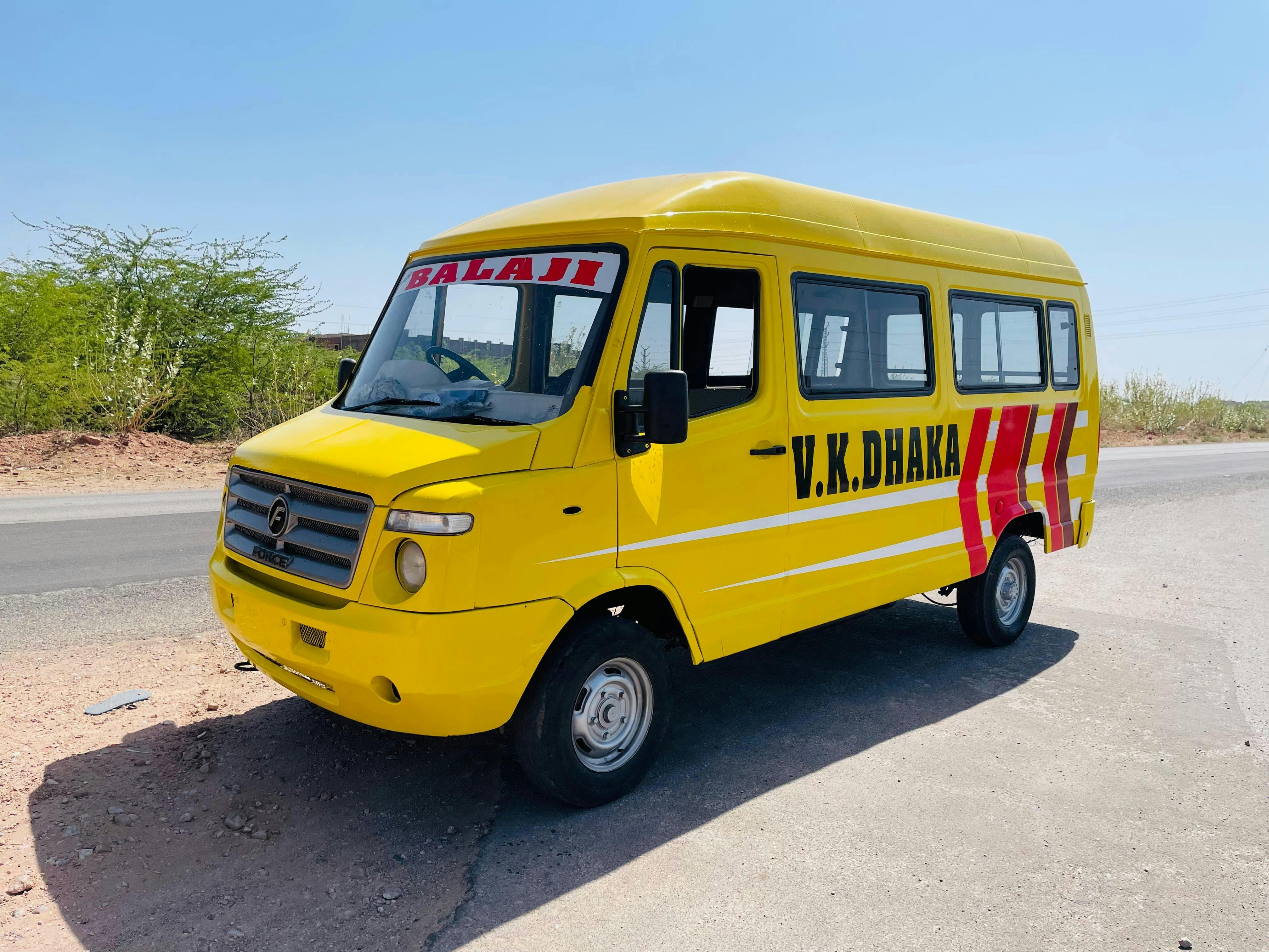 Bright Yellow Passenger Van on Rural Roadside · Free Stock Photo