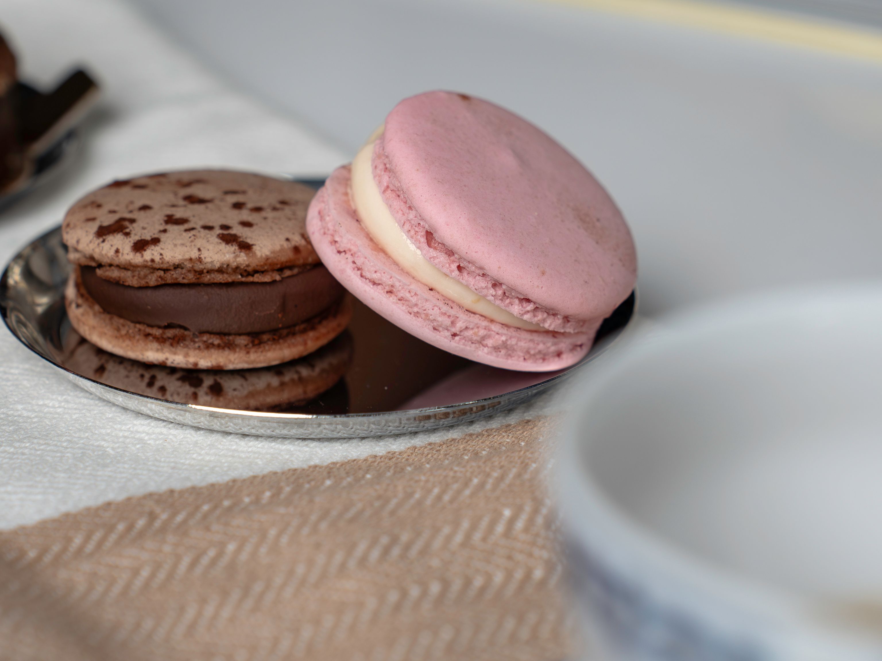 Close-Up of Gourmet French Macarons on Plate · Free Stock Photo