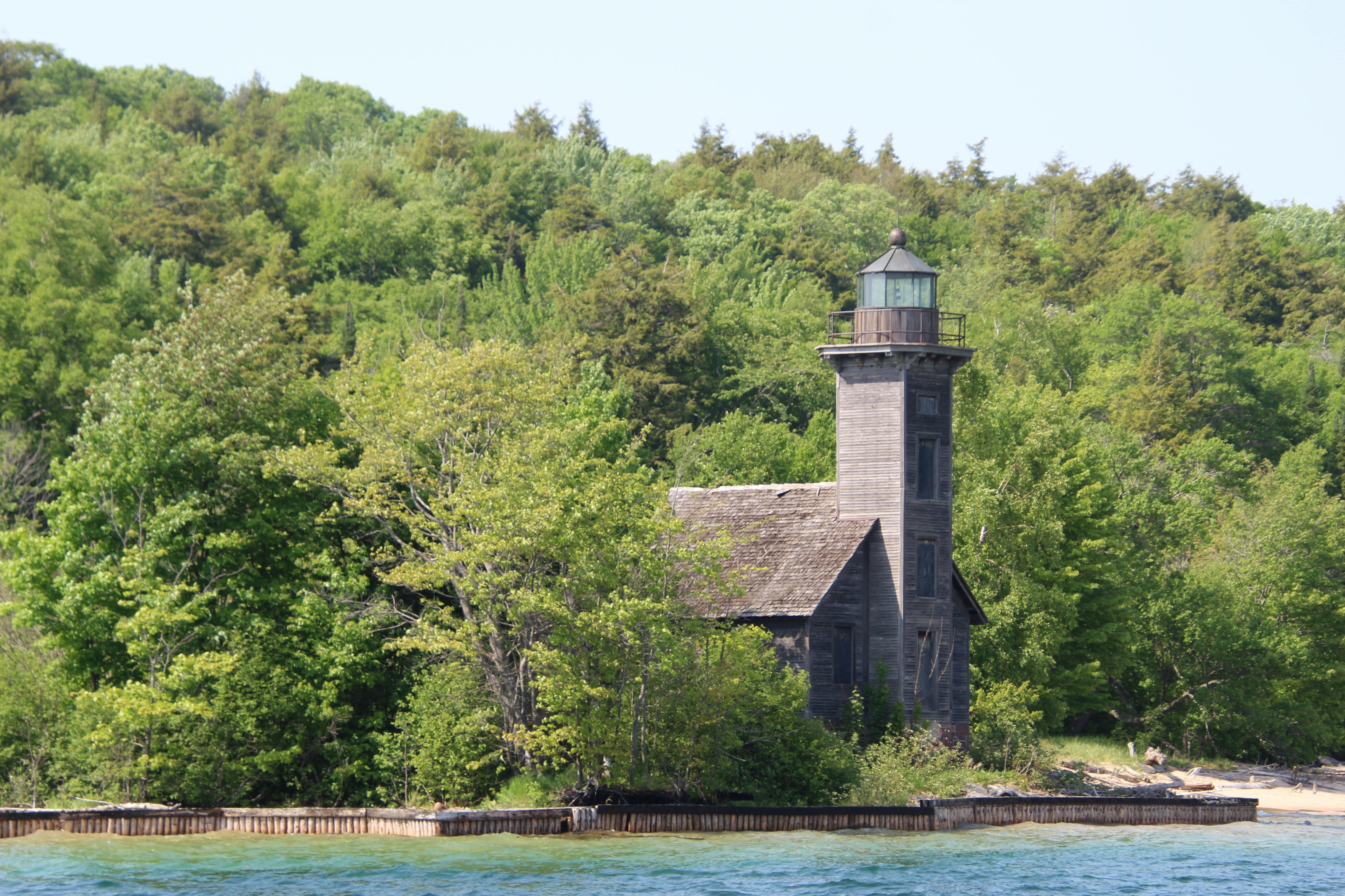 Rustic Lighthouse Amid Lush Forest by Lakeside · Free Stock Photo