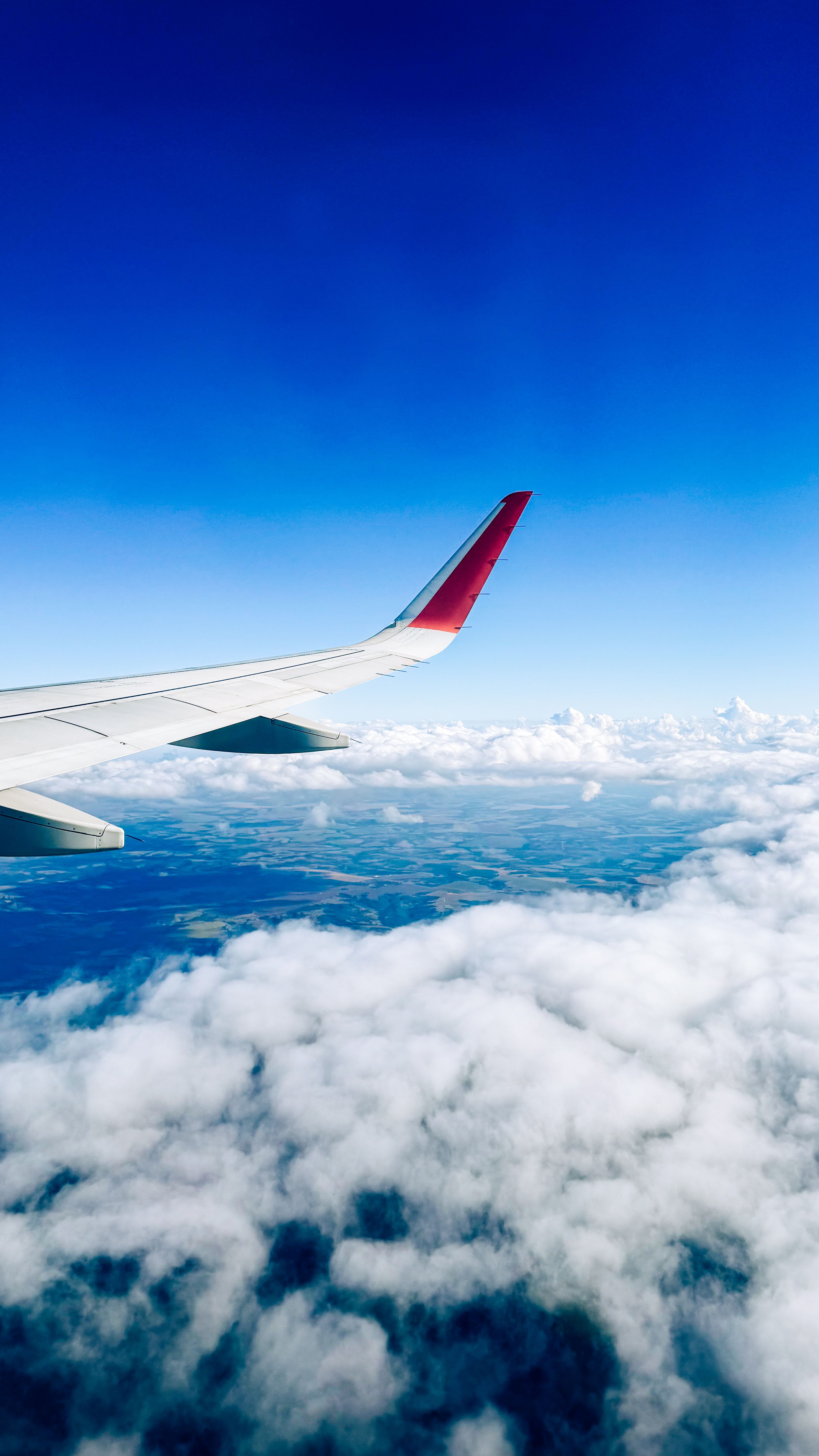 Aerial View of Airplane Wing Above Clouds · Free Stock Photo