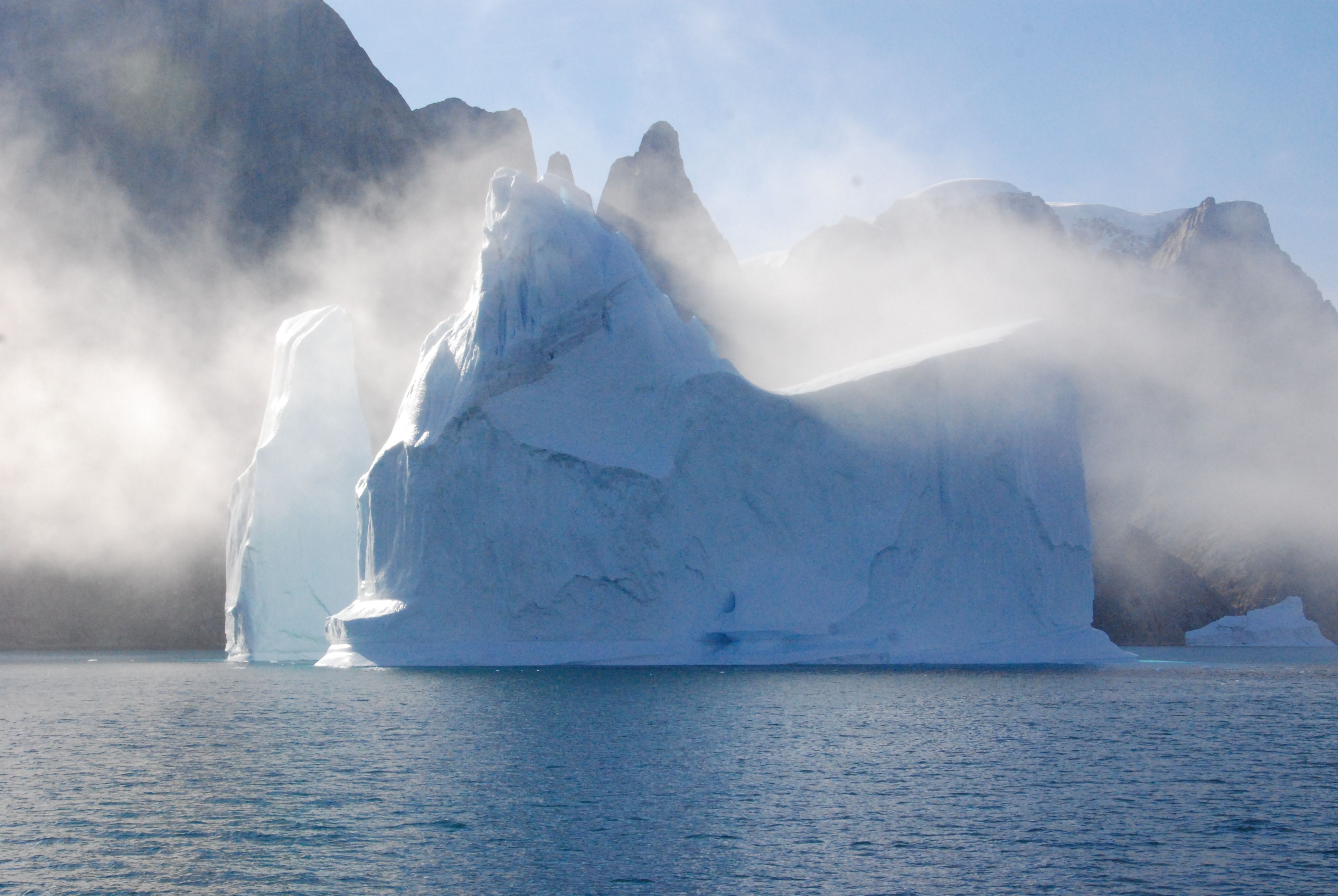 Majestic Iceberg in Arctic Waters Under Fog · Free Stock Photo