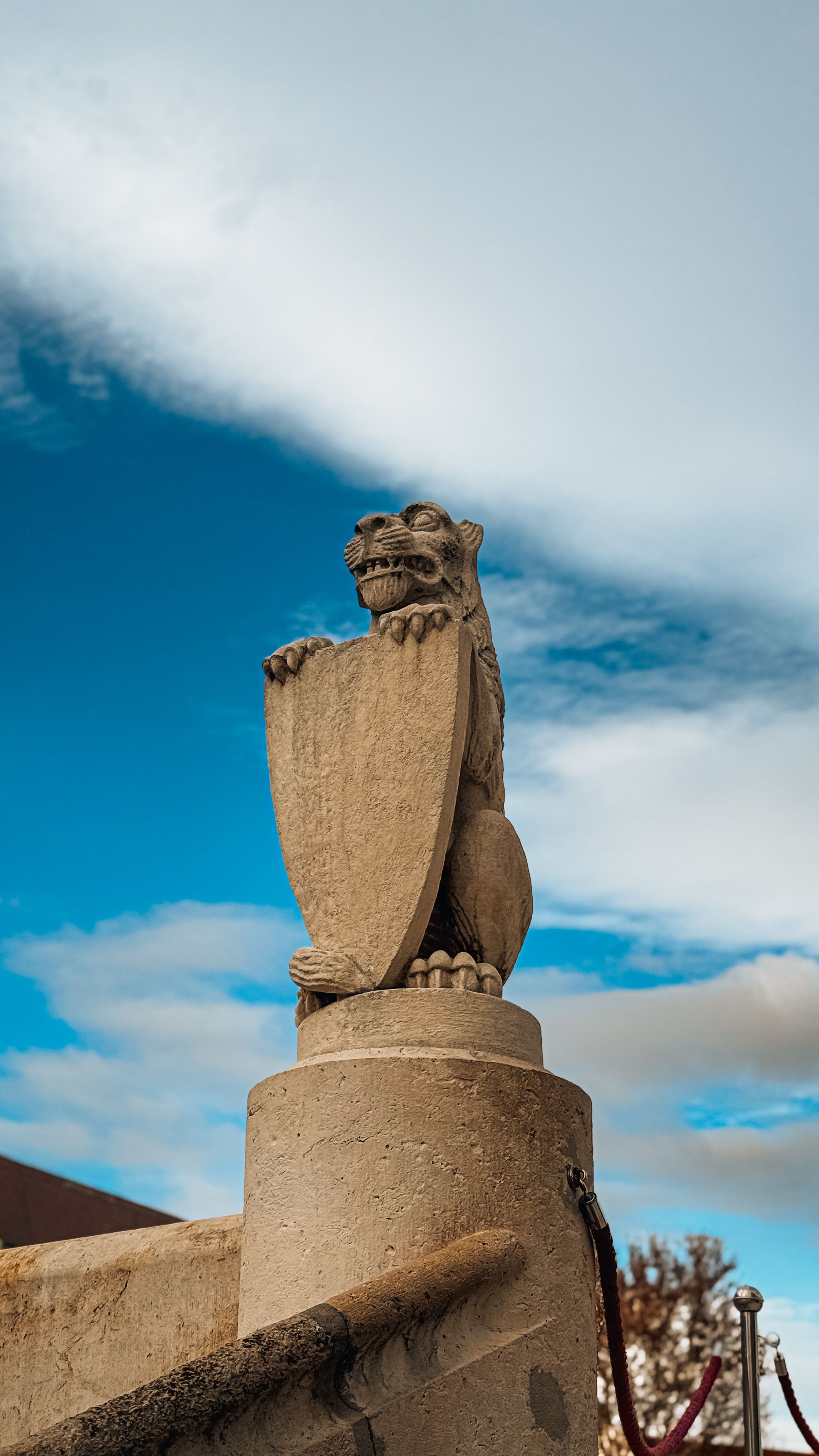 Gargoyle Statue on Castle Wall with Blue Skies · Free Stock Photo