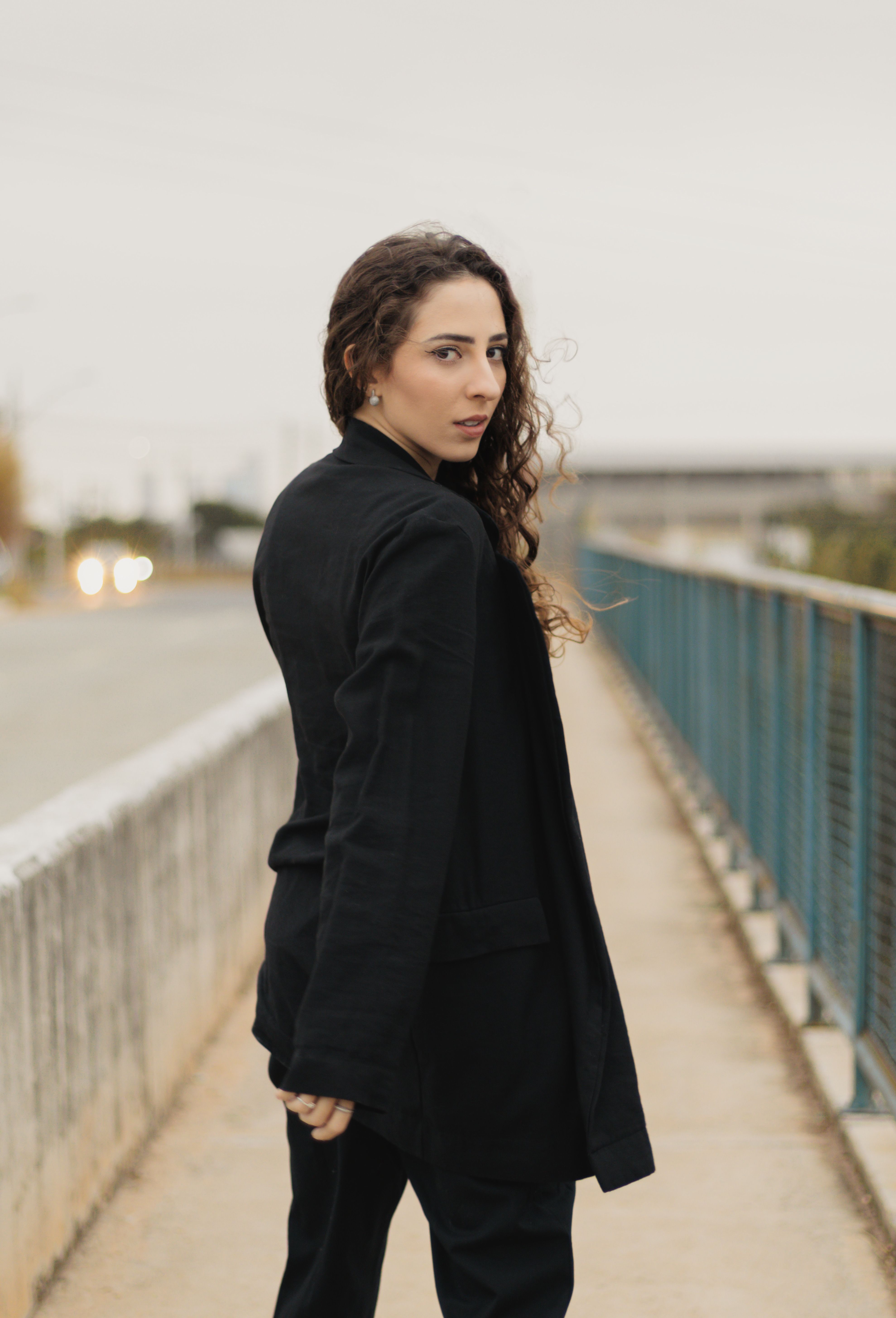 Confident Woman Walking on Urban Sidewalk · Free Stock Photo