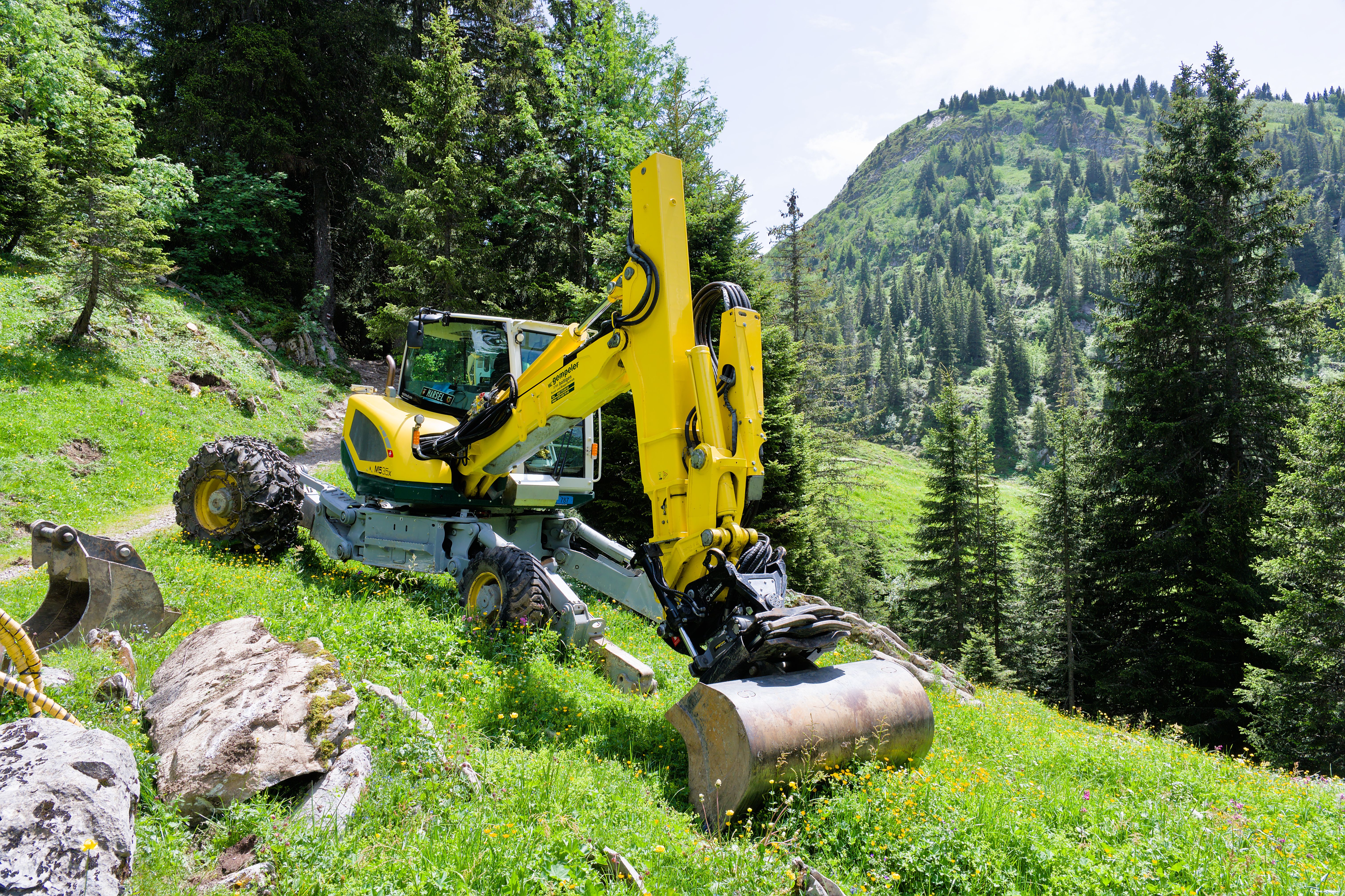 Excavator in Alpine Forest Landscape · Free Stock Photo
