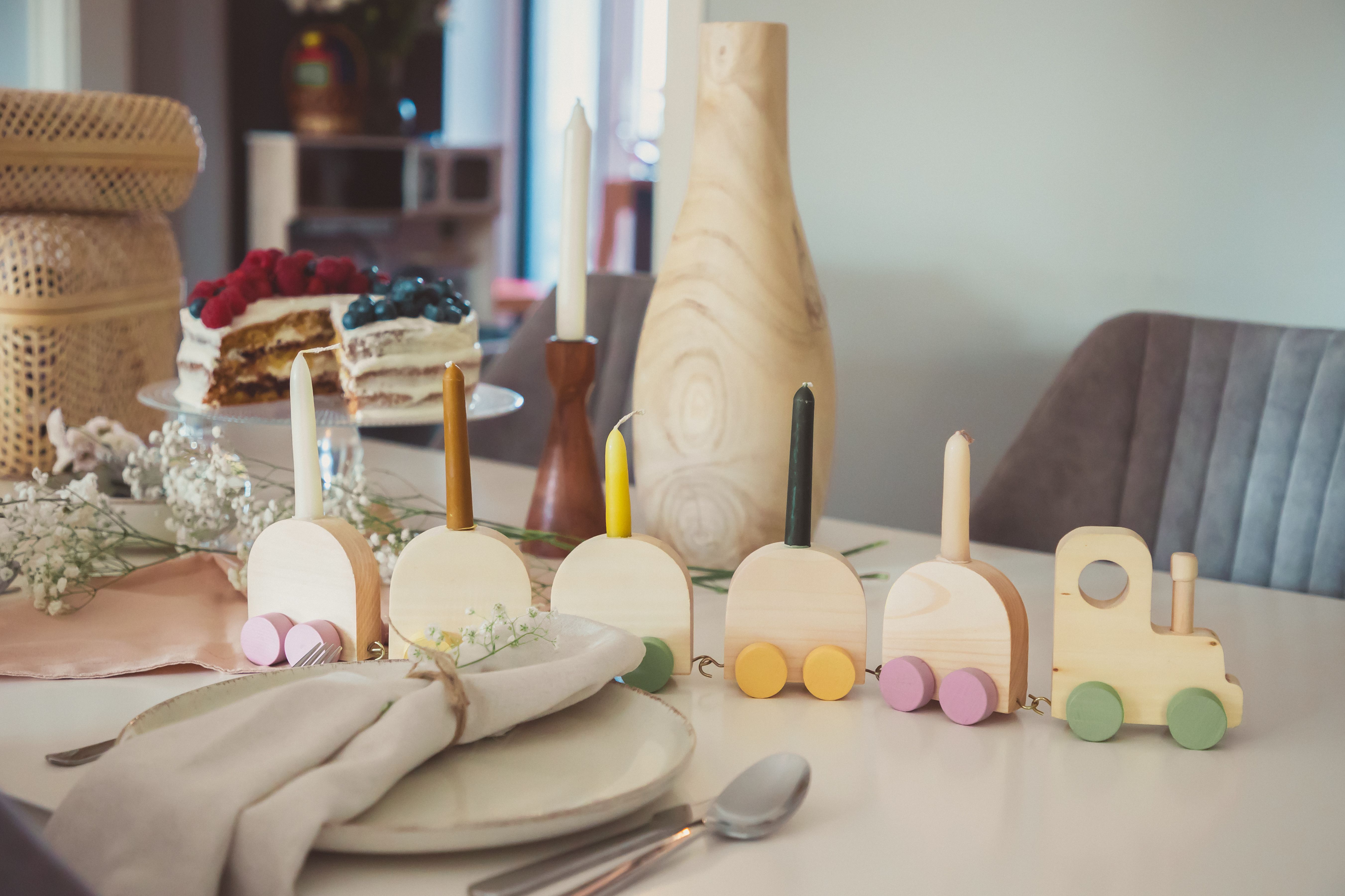 Charming Table Setting with Wooden Train Decor · Free Stock Photo