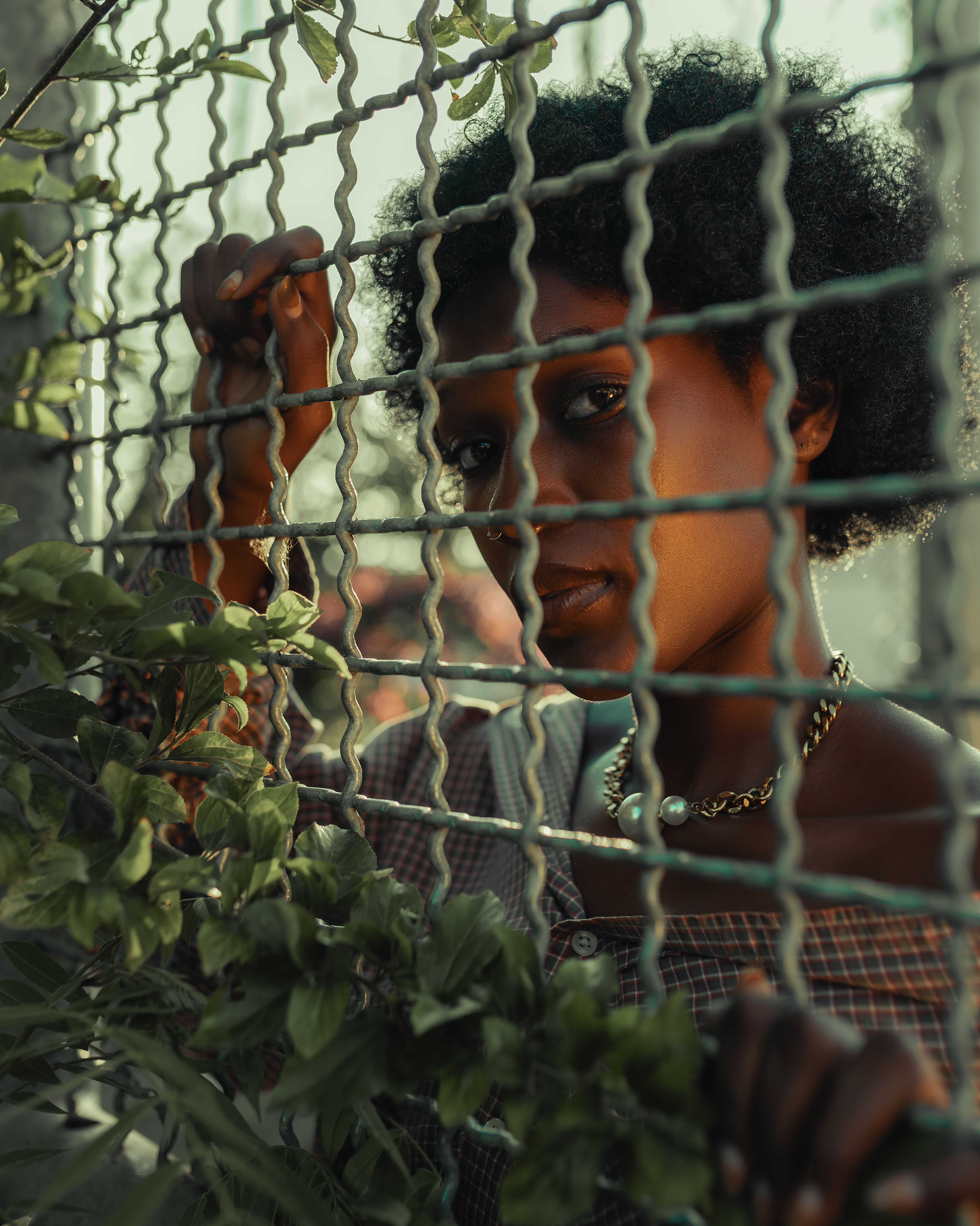 Creative Portrait of Woman Through Wire Fence Outdoors · Free Stock Photo