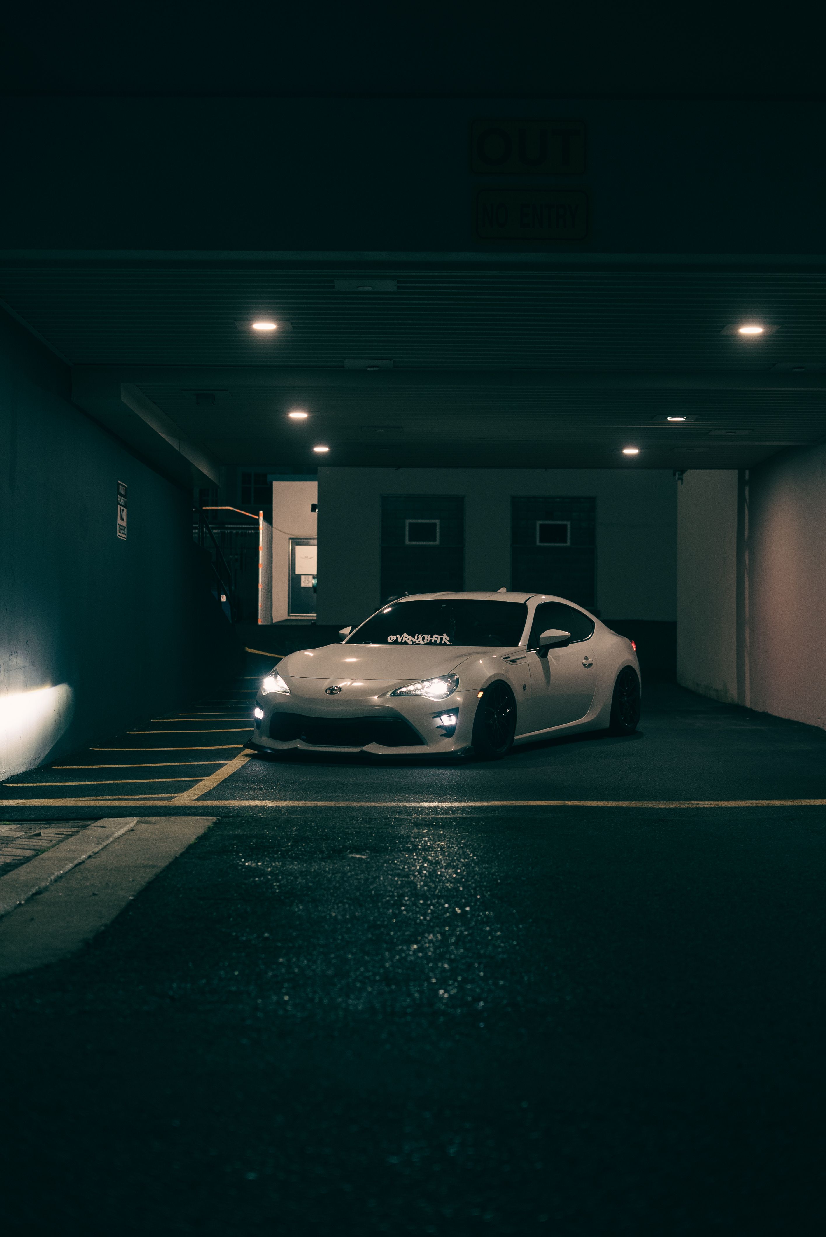 Sleek White Sports Car in Dimly Lit Garage · Free Stock Photo