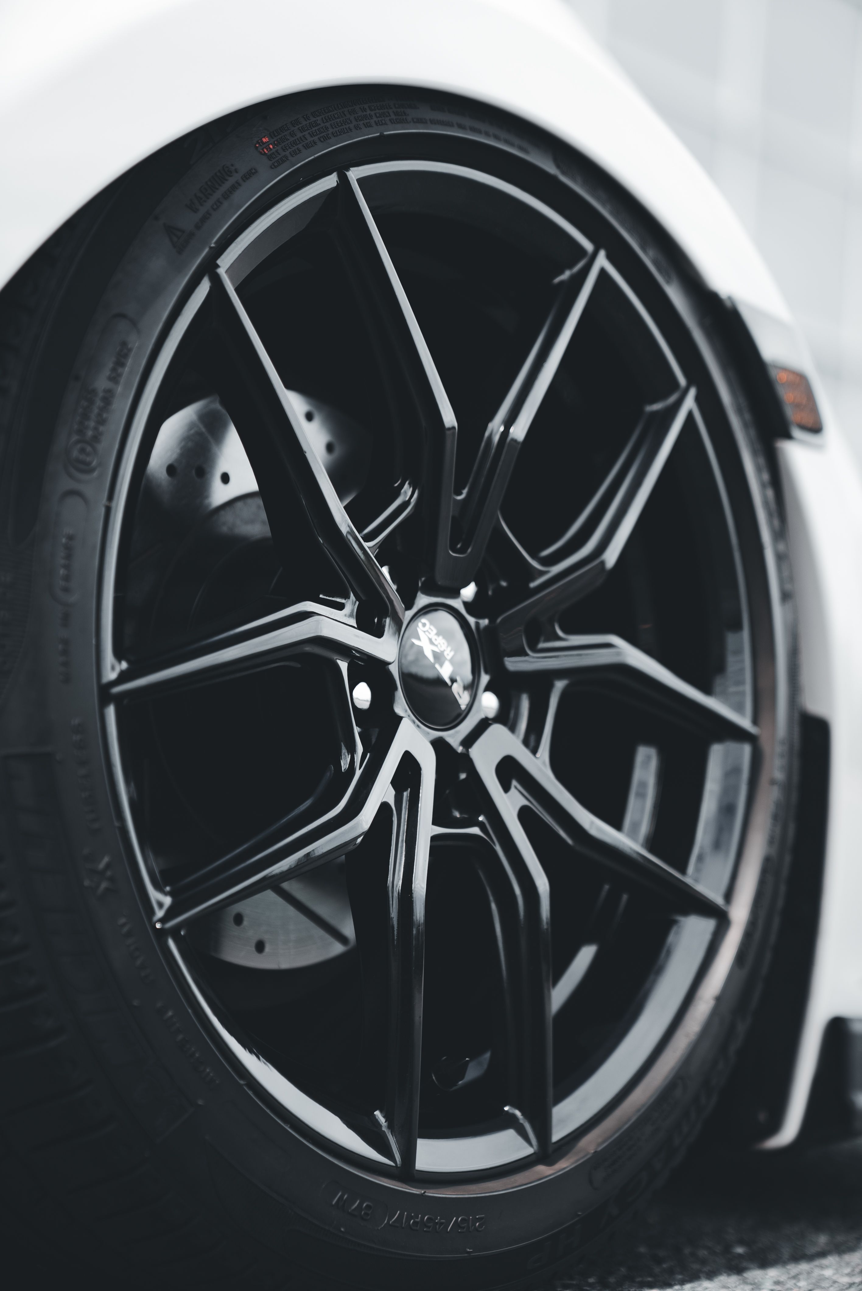 Close-up of Black Alloy Wheel on Sports Car · Free Stock Photo