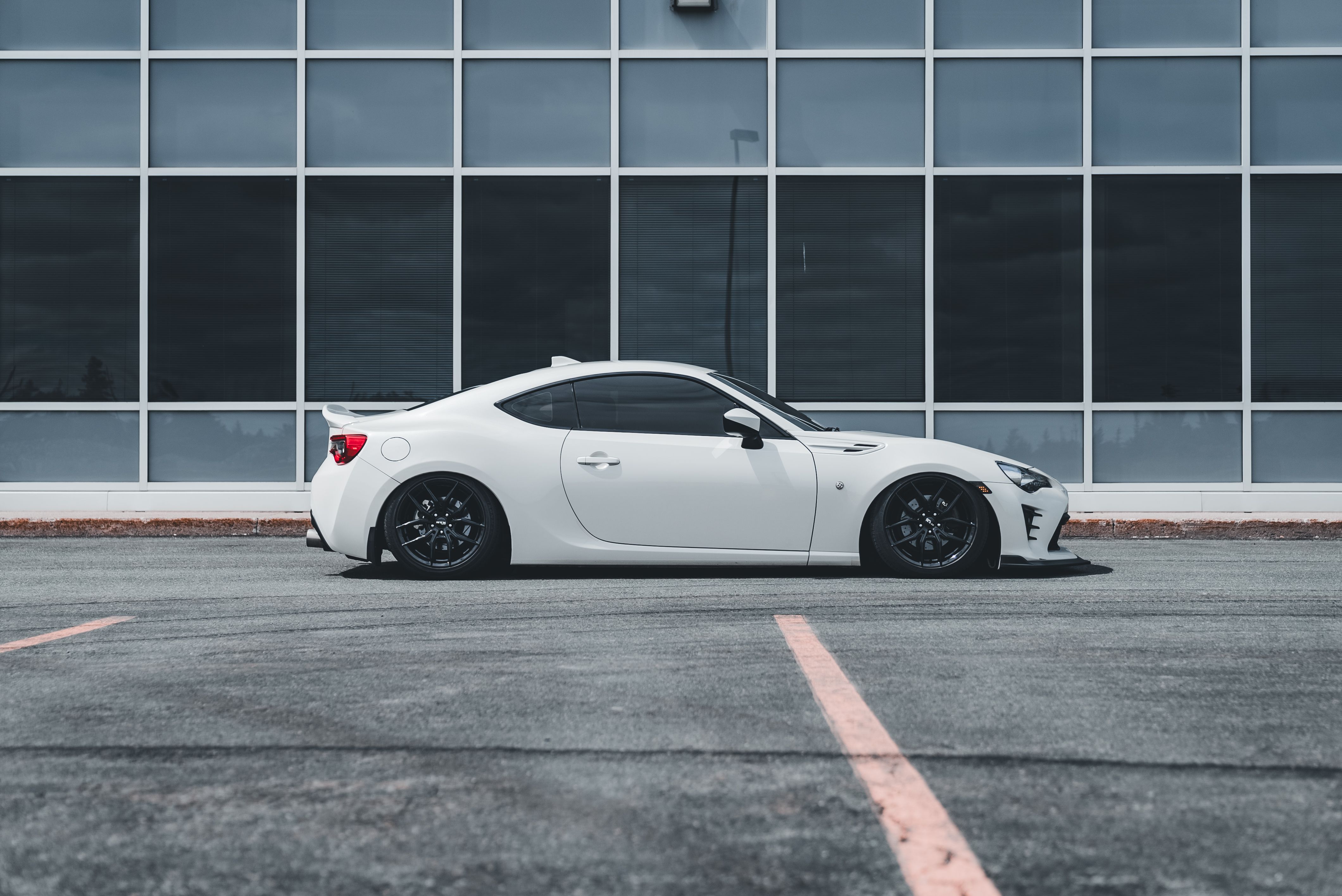White Sports Car by Serene Lakefront Setting · Free Stock Photo