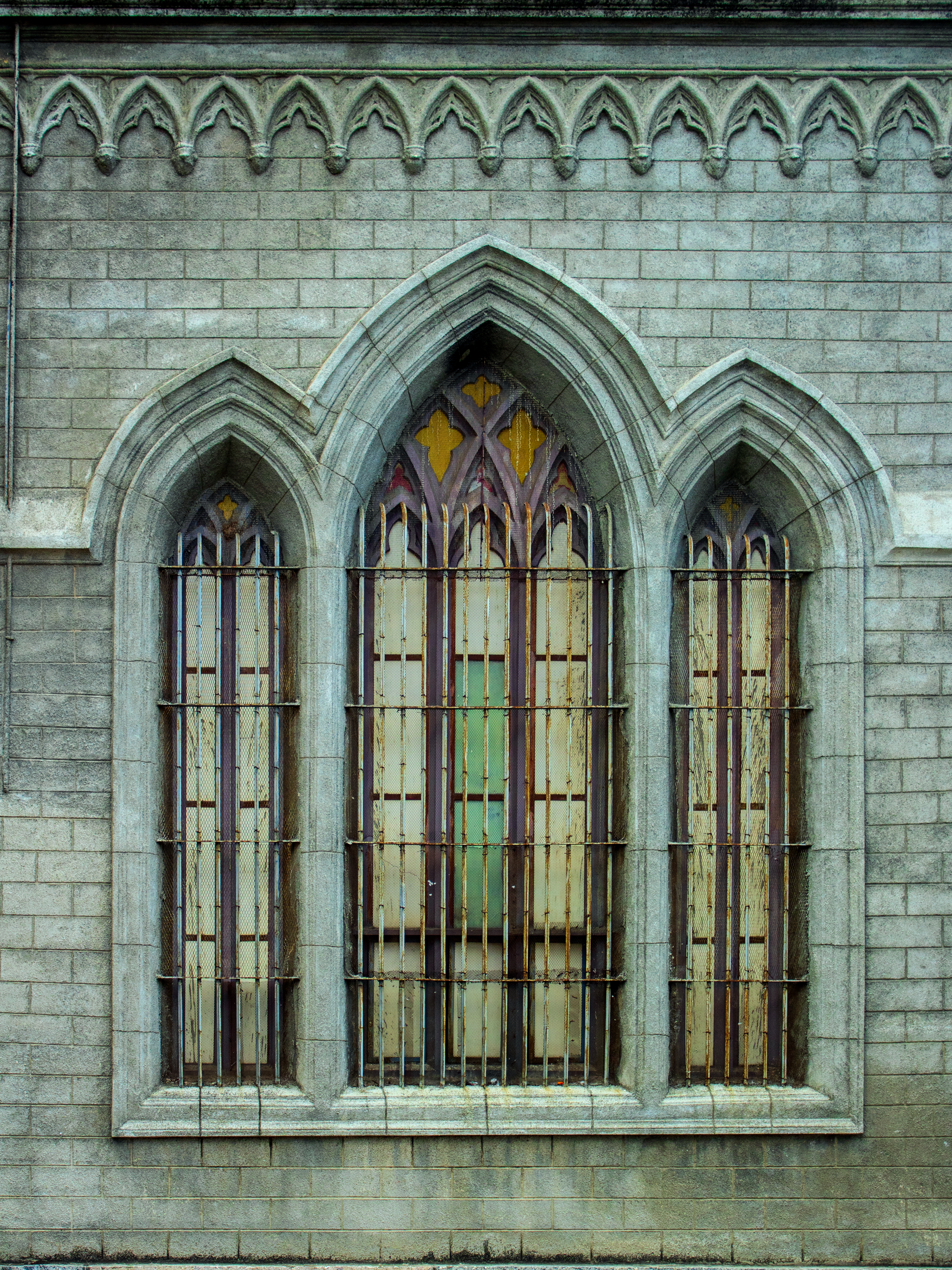 Gothic Arched Windows with Iron Bars on Stonewall · Free Stock Photo